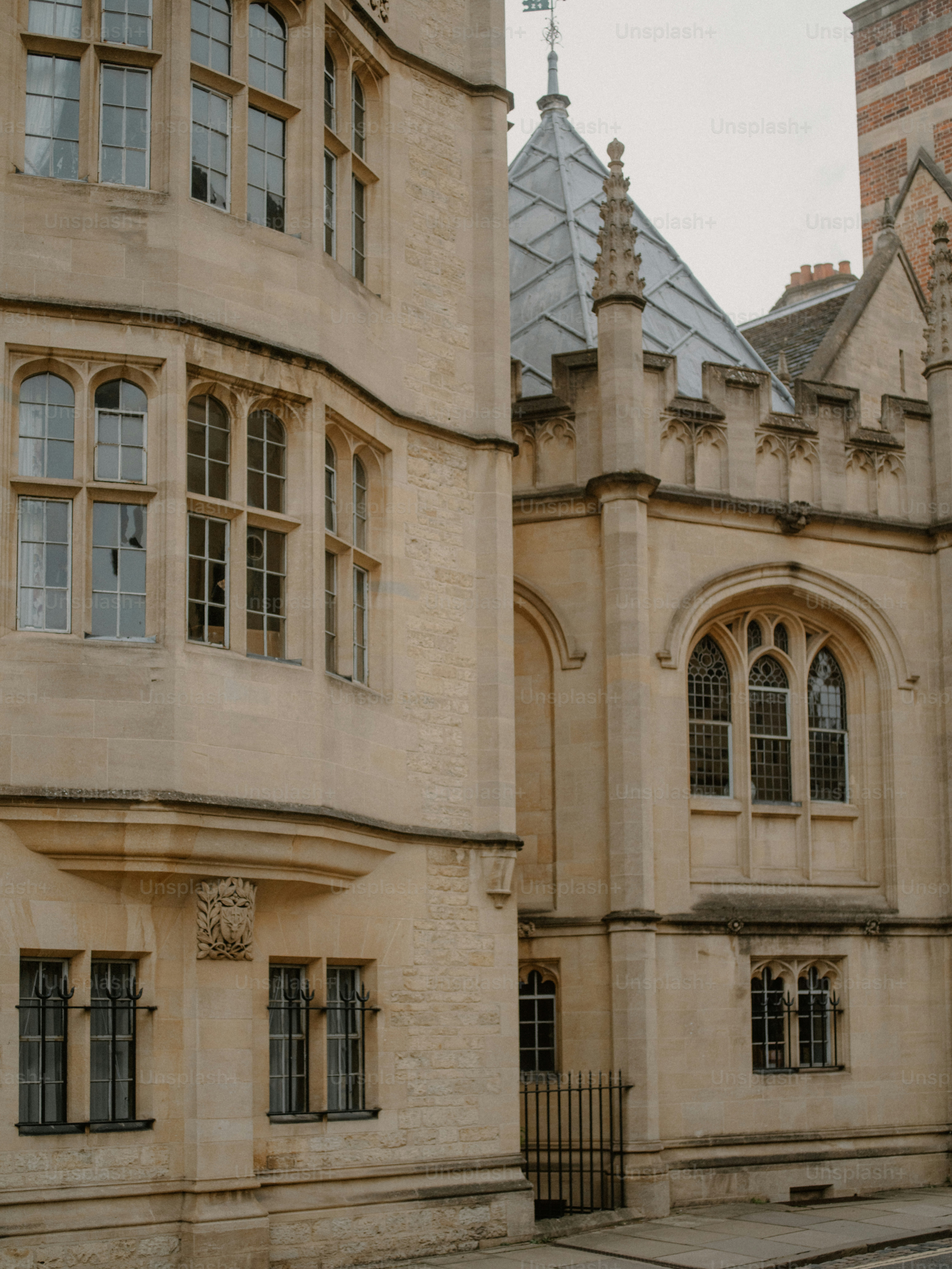 Old stone building with large windows and birds flying. photo – England ...
