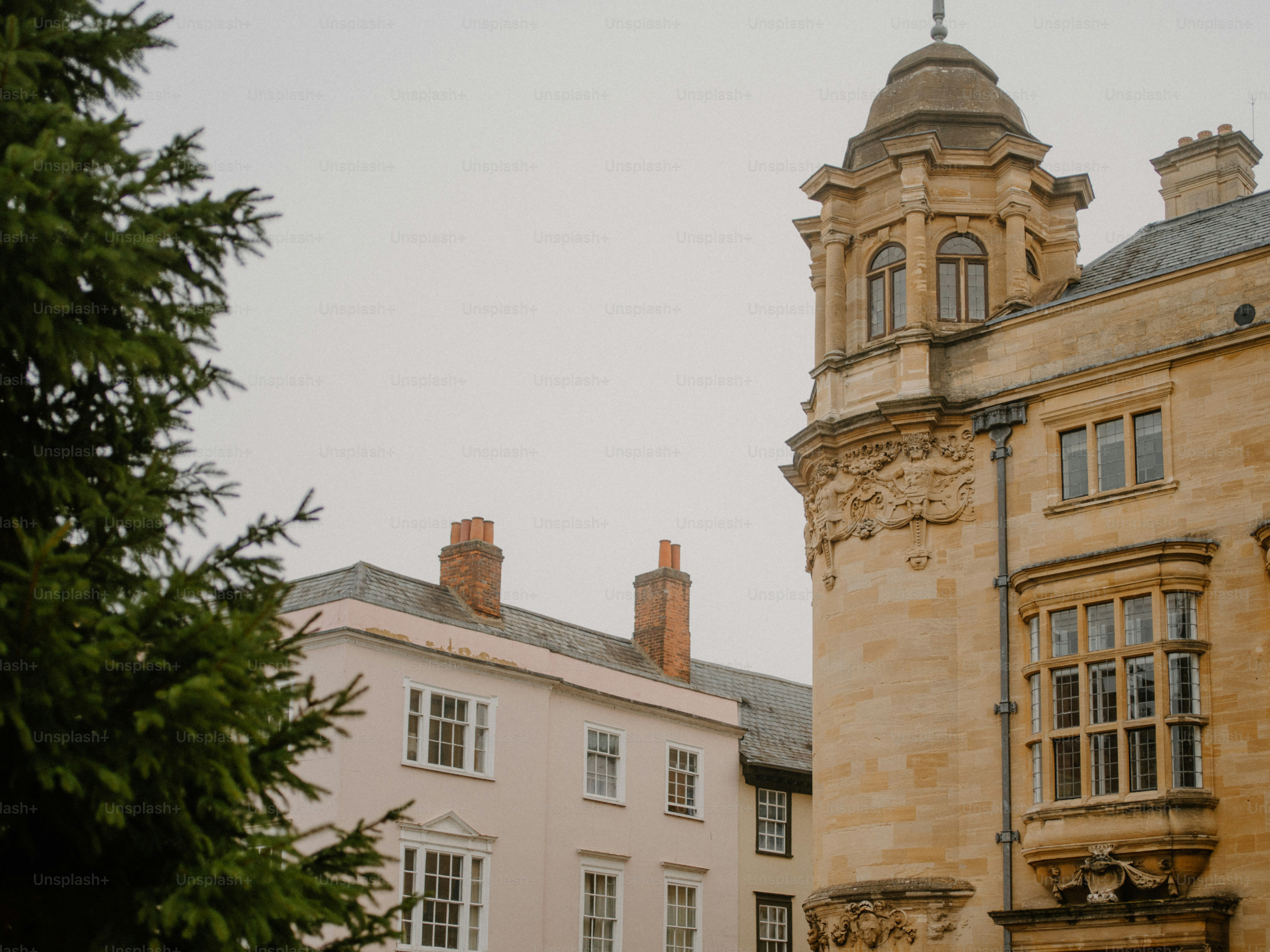 Old stone building with large windows and birds flying. photo – England ...