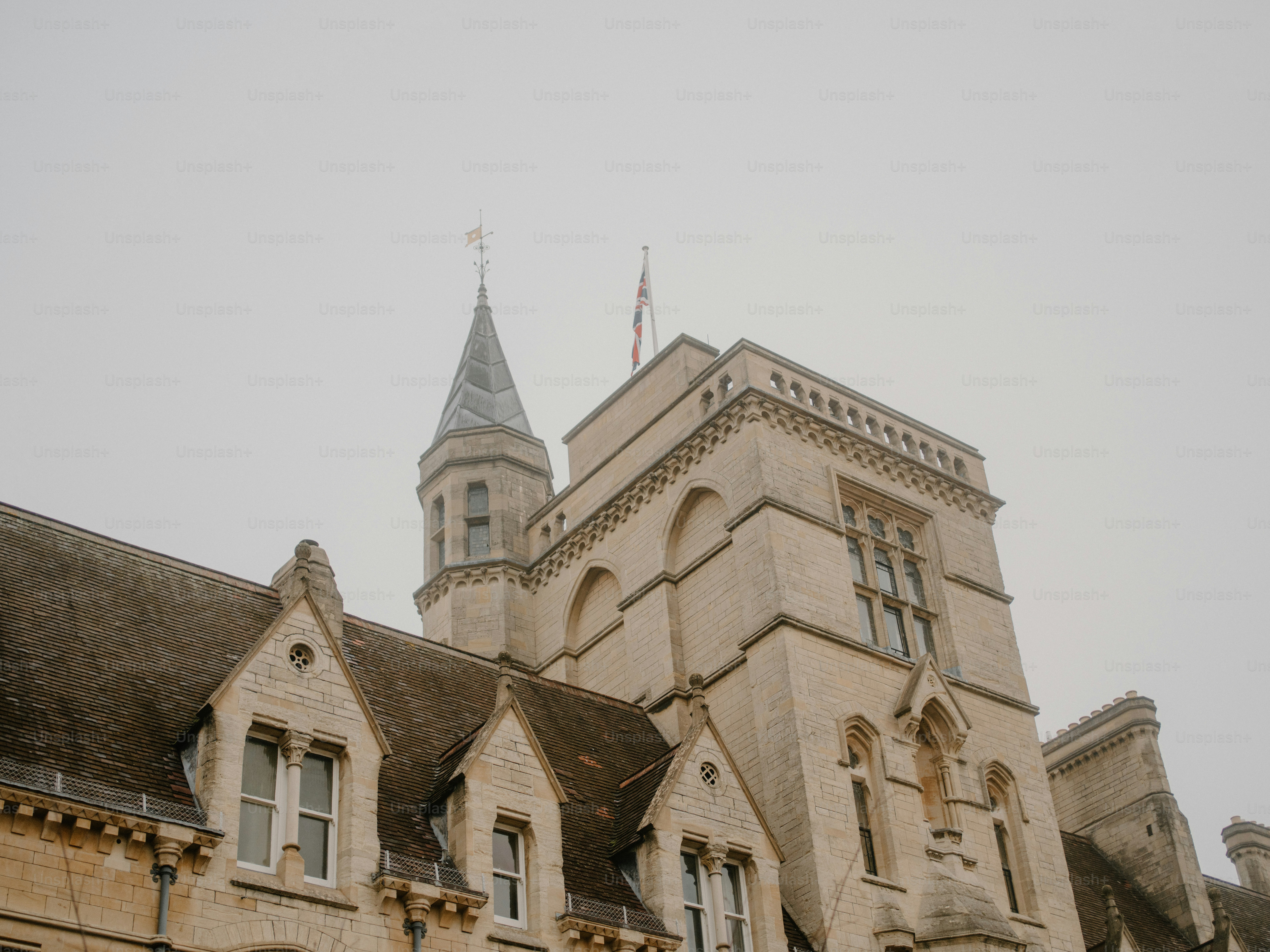 Ornate gothic windows on a stone building facade photo – Architecture ...
