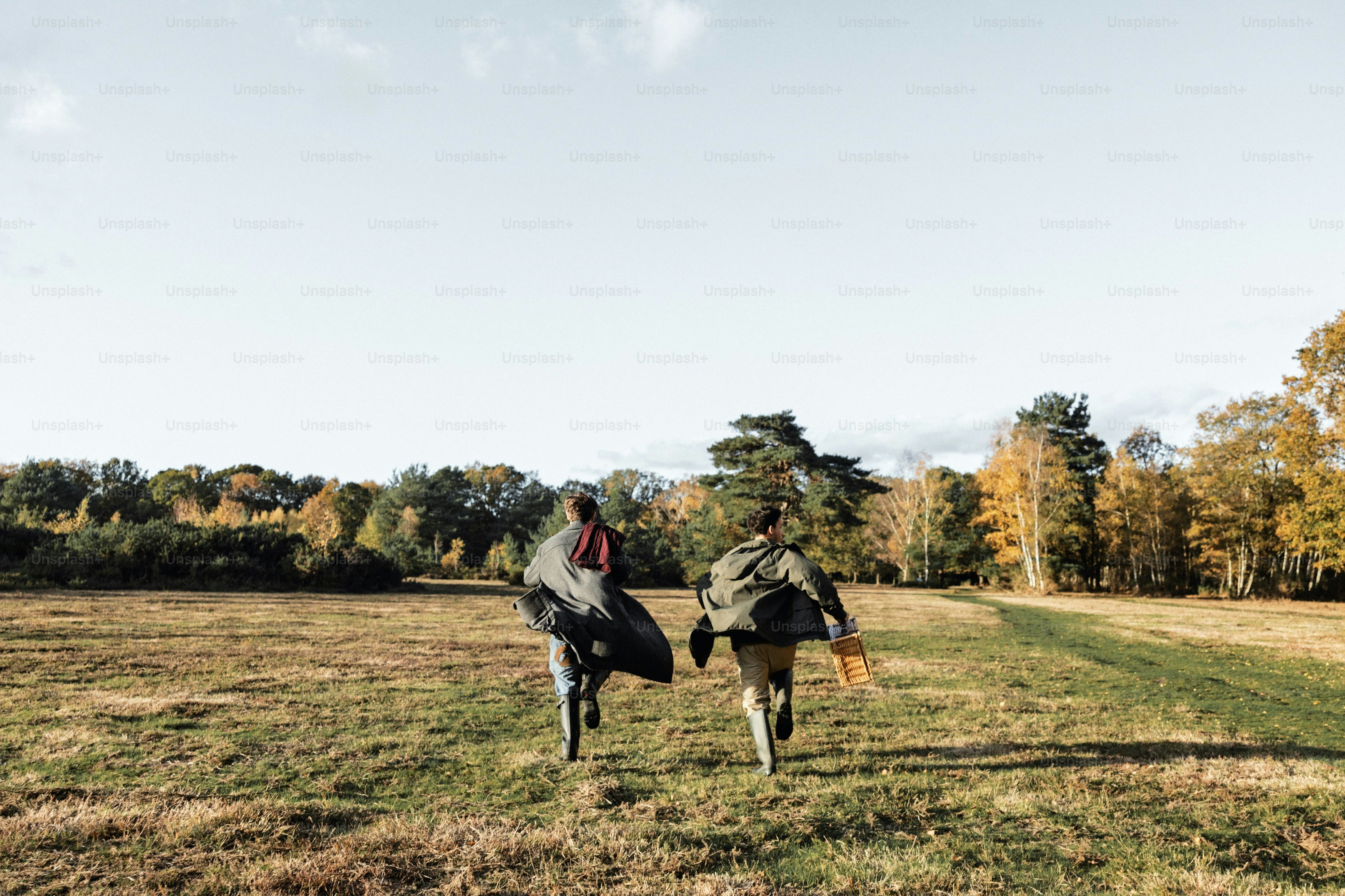 Two people running through a field with a basket. photo – Autumn Image ...