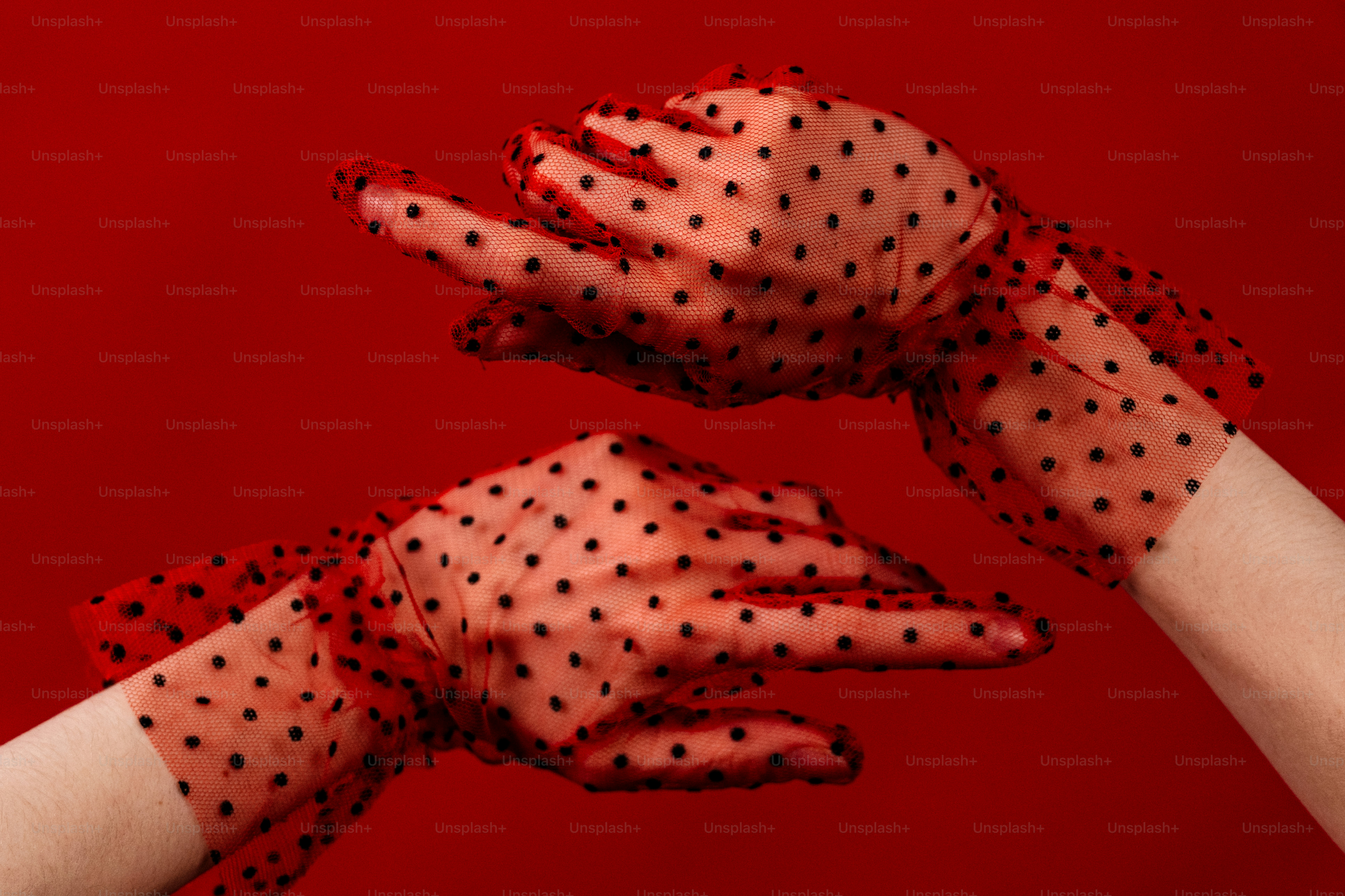 Pair of hands wearing sheer red polka dot gloves photo – Pattern Image ...