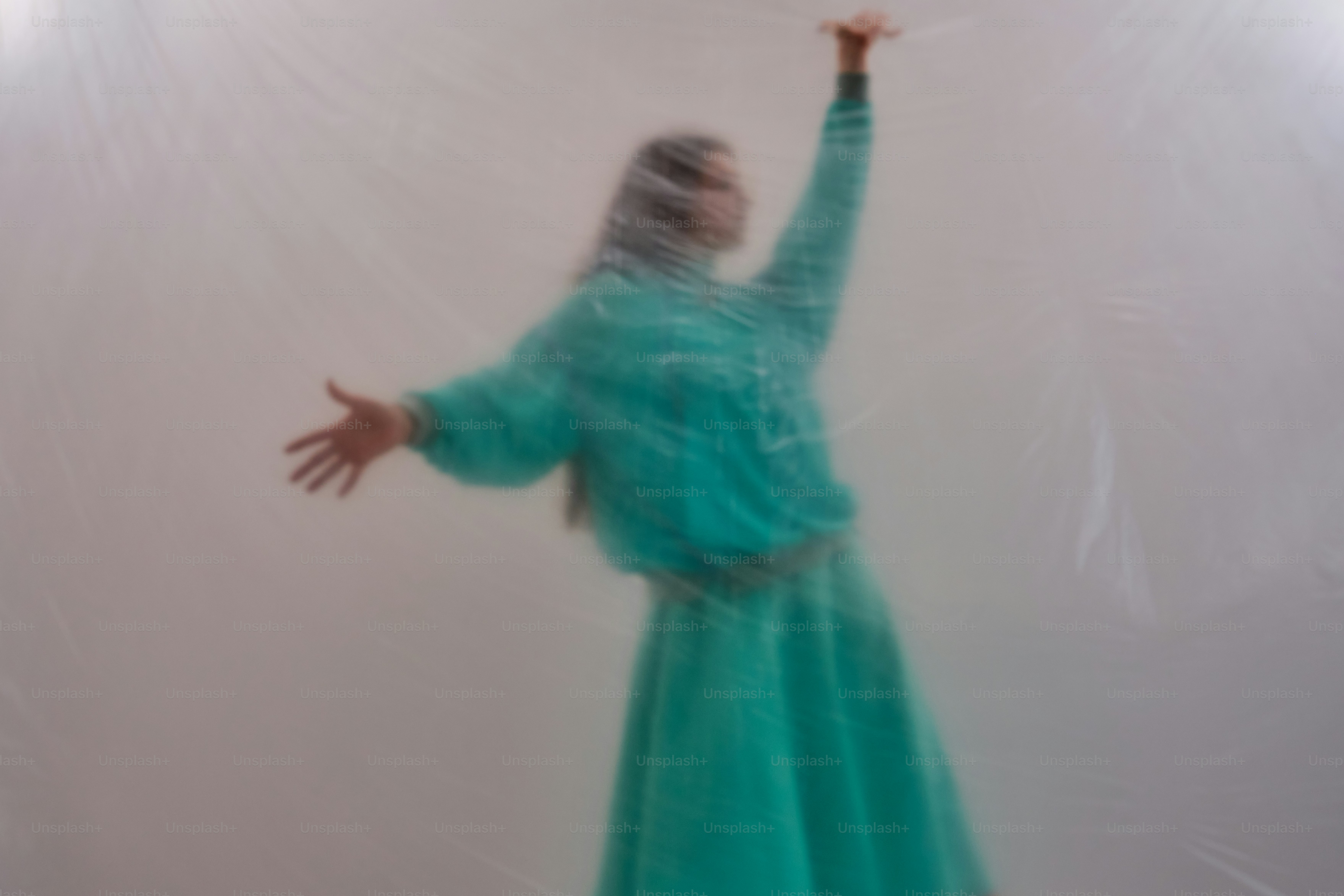 Woman in teal dress dancing with arms outstretched photo – Portrait ...