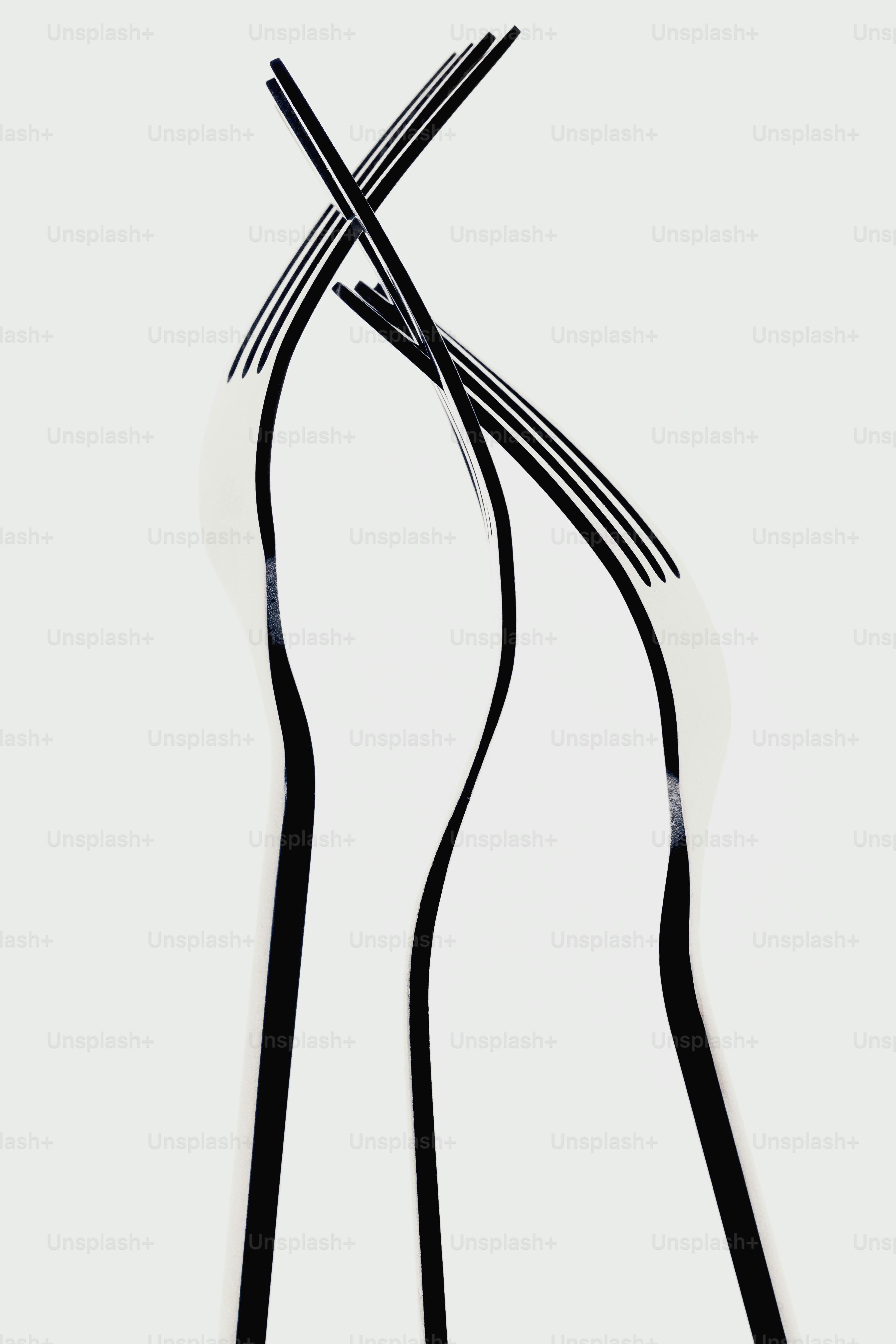 Two forks crossed against a white background photo – White background ...