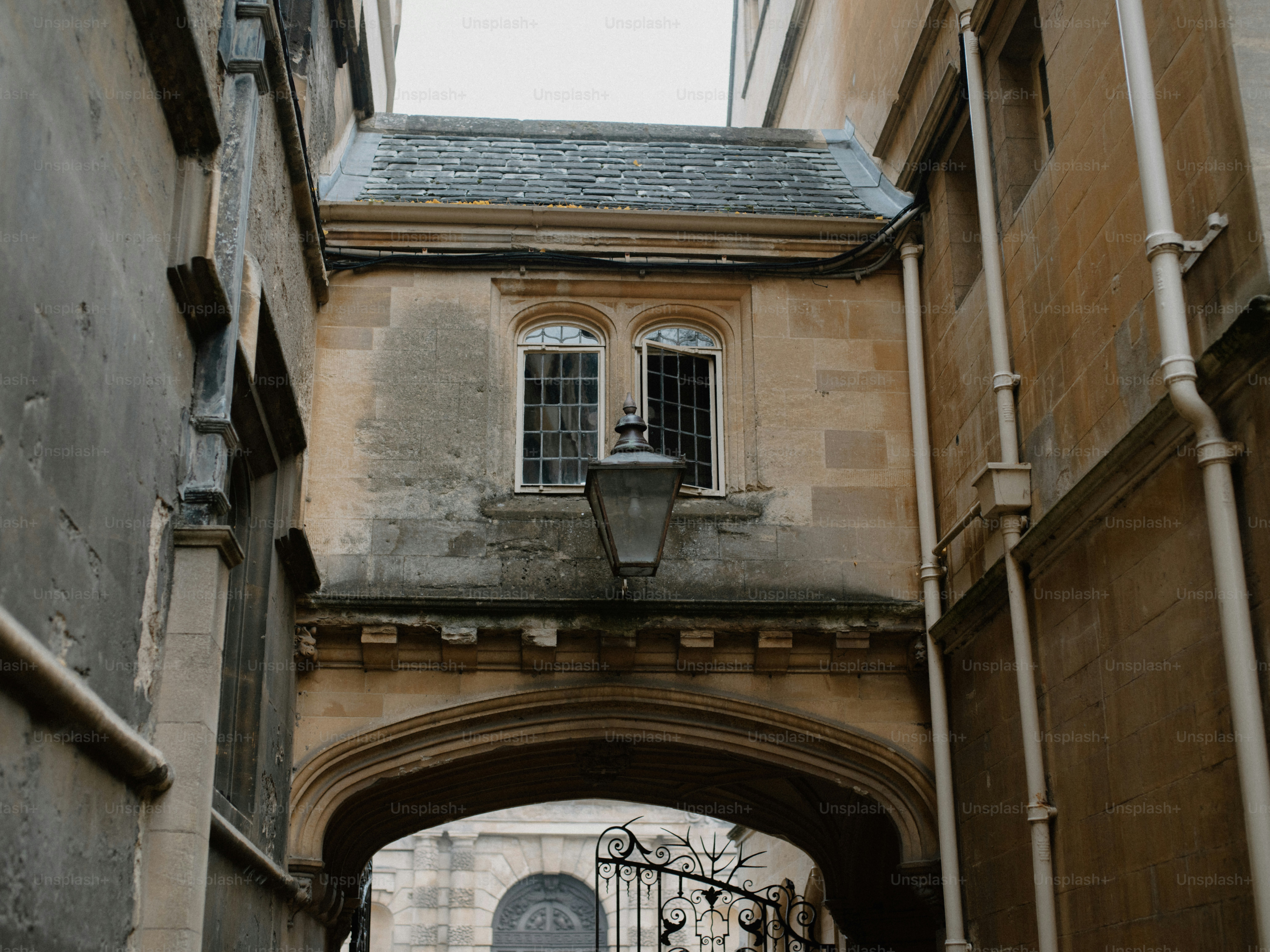 An old stone bridge connecting two buildings photo – Architecture Image ...