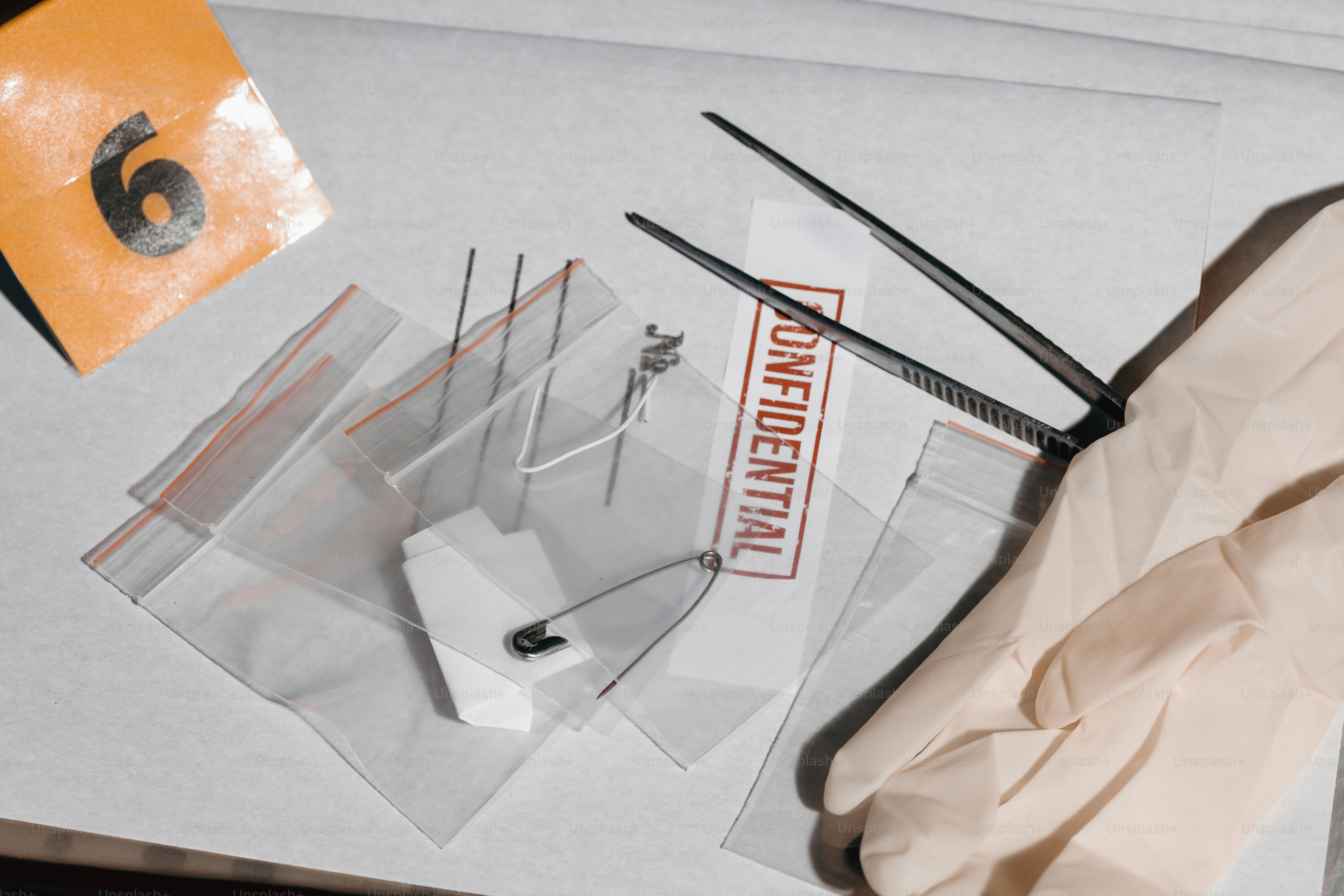 Crime scene evidence including pins and a safety pin. photo – Documents ...