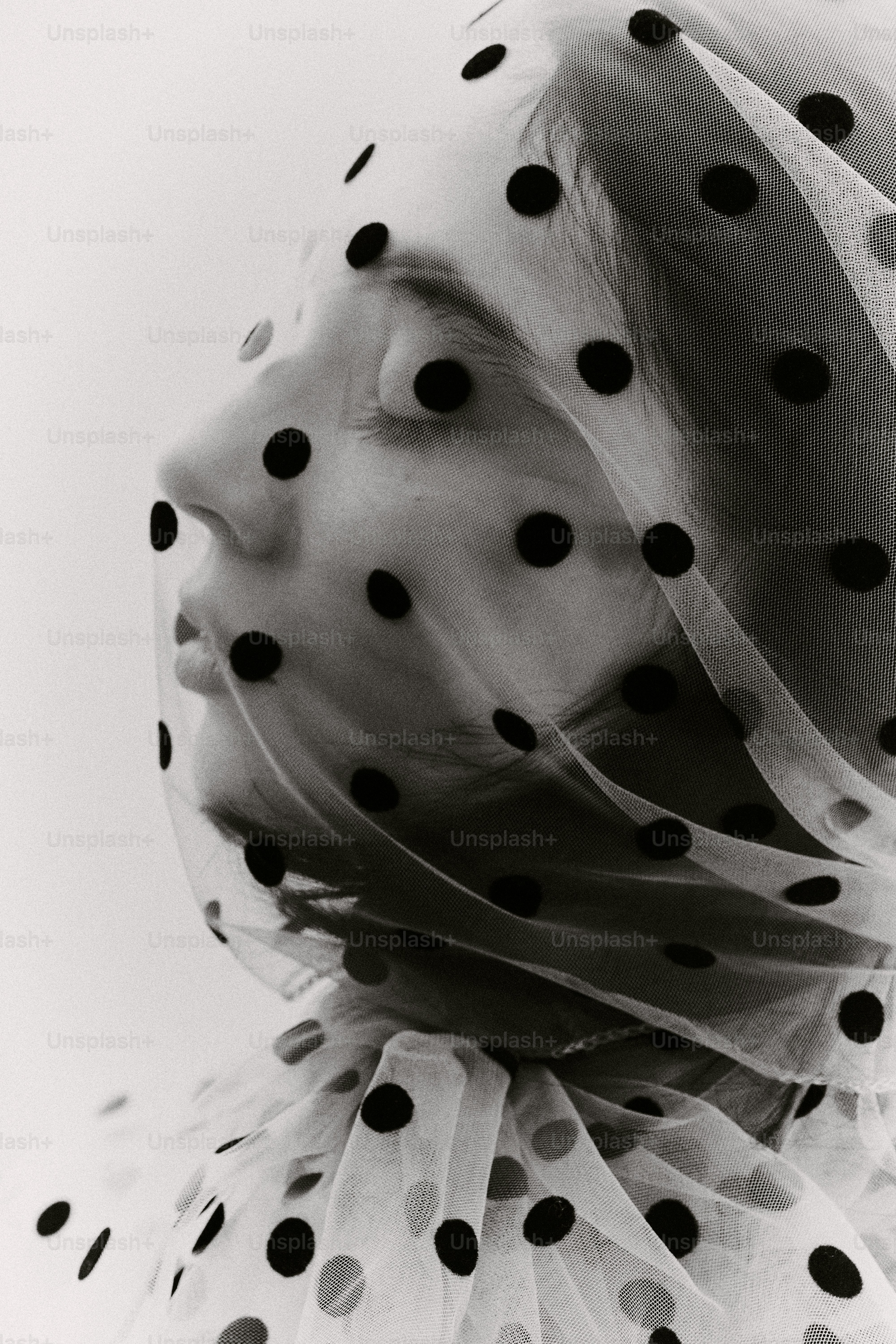 Woman in sheer polka dot fabric covering face photo – Portrait Image on ...