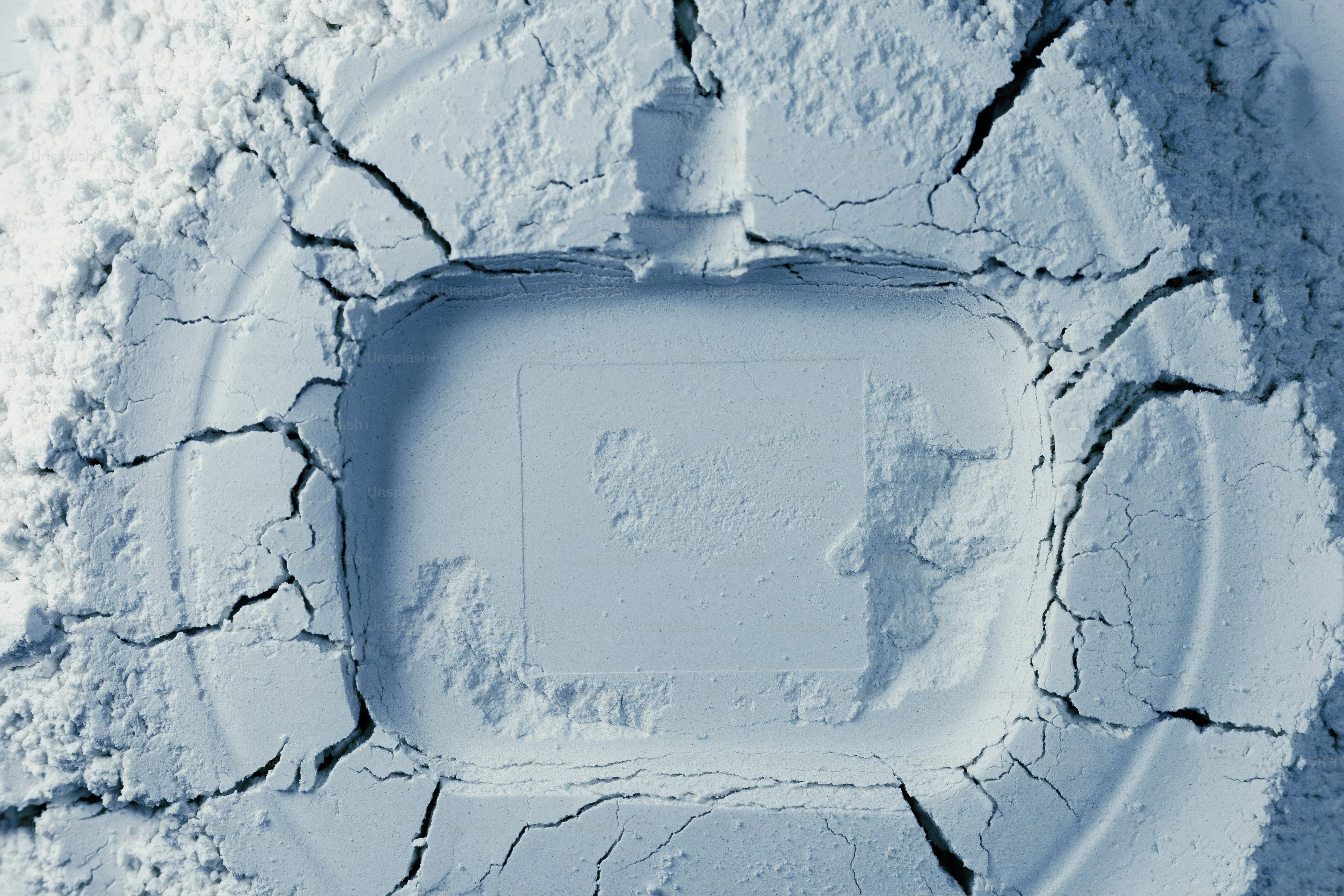 Cracked white powder surrounds a rectangular indentation. photo – Blue ...