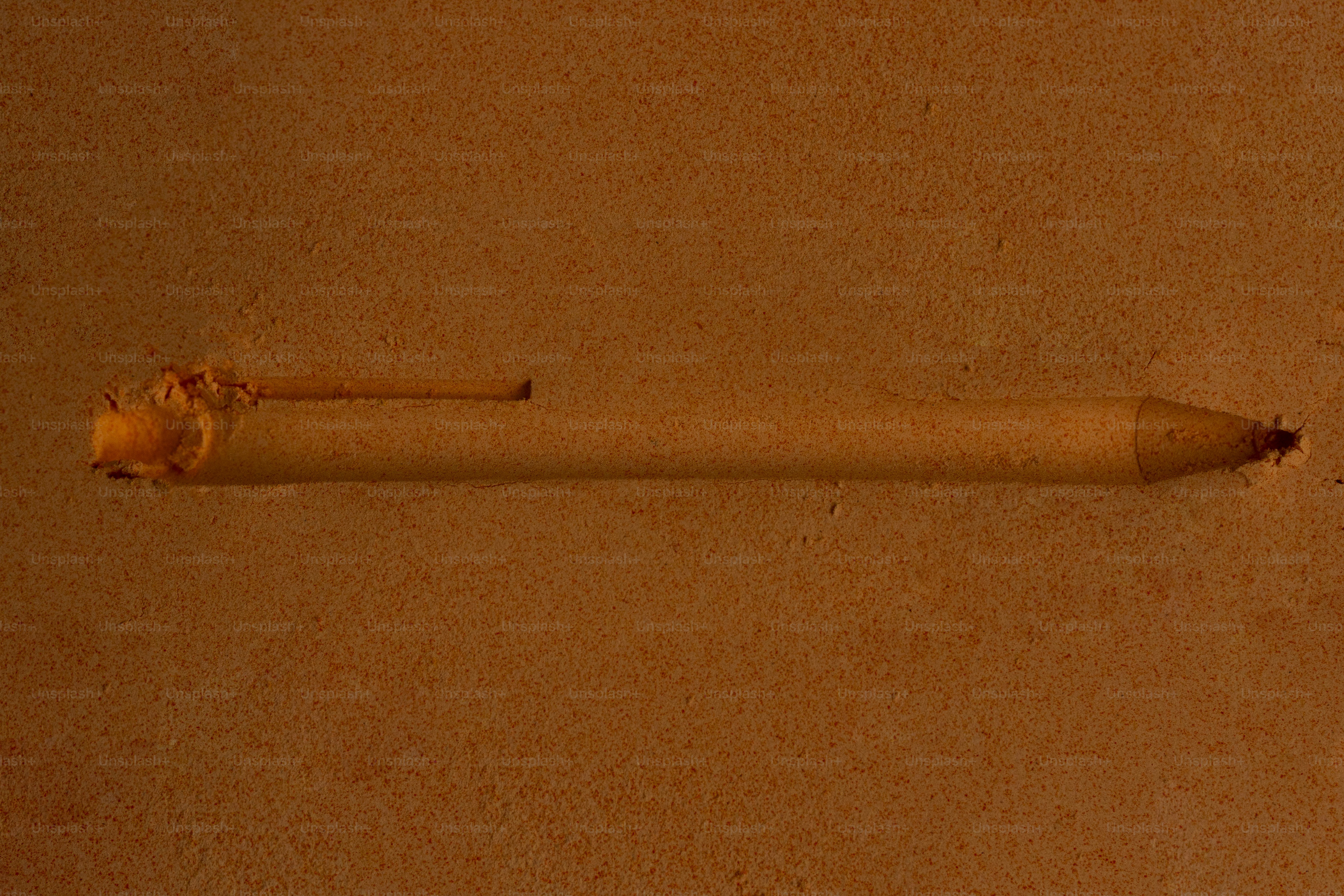 A close-up of a pen on a textured surface. photo – Abstract Image on ...