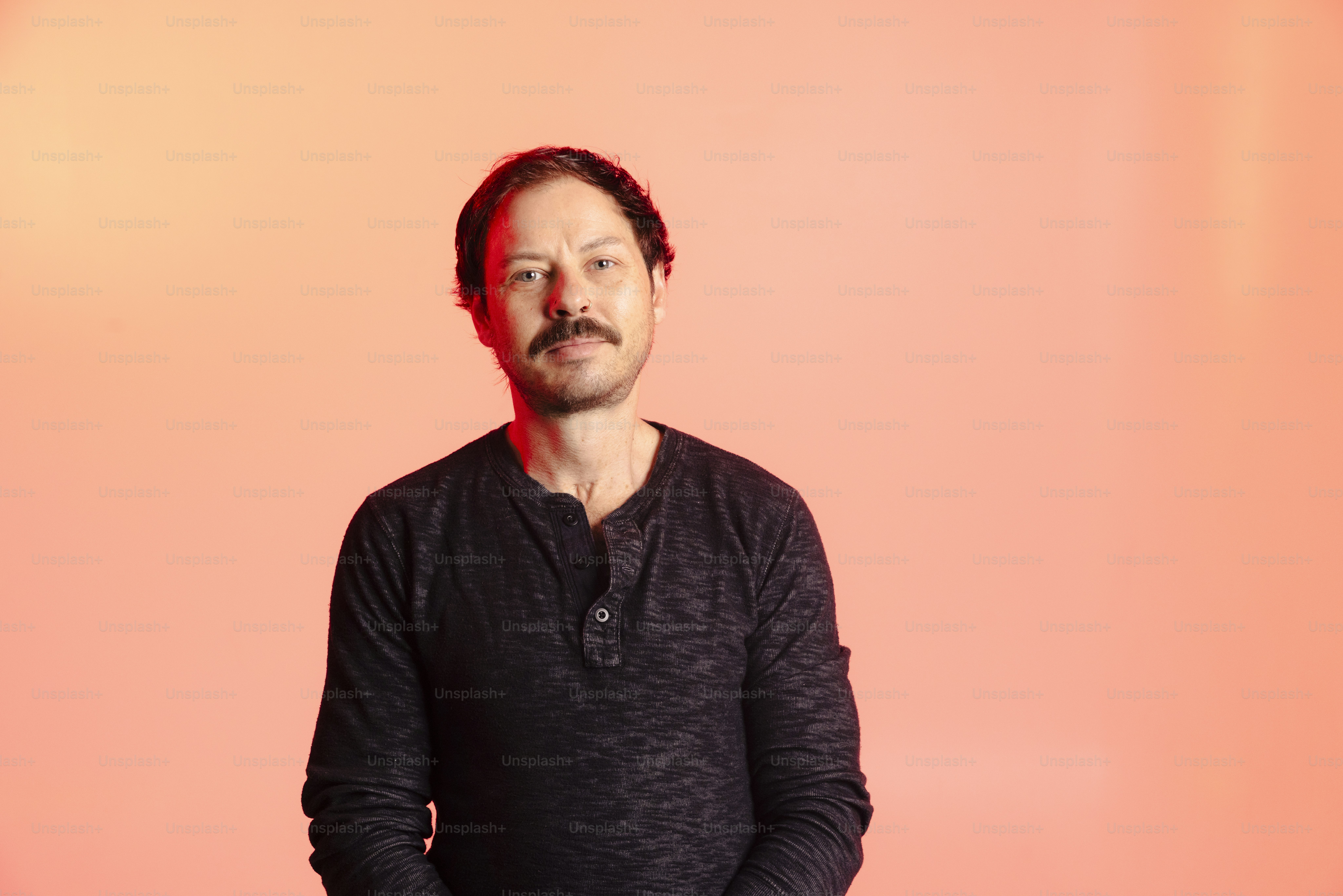 Man with mustache and nose ring against purple background photo ...