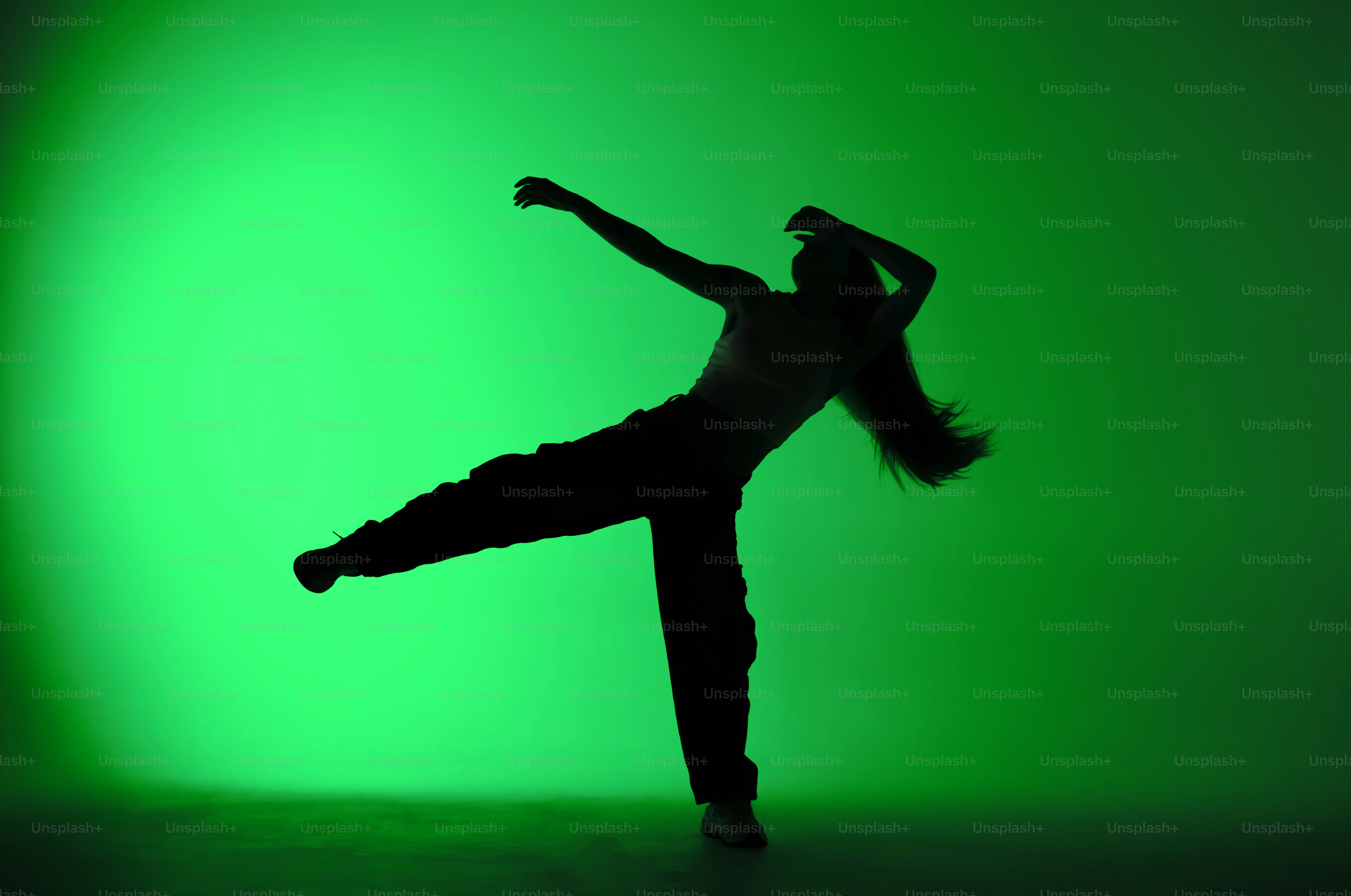 Silhouette of a dancer in a dramatic pose photo – Abstract Image on ...