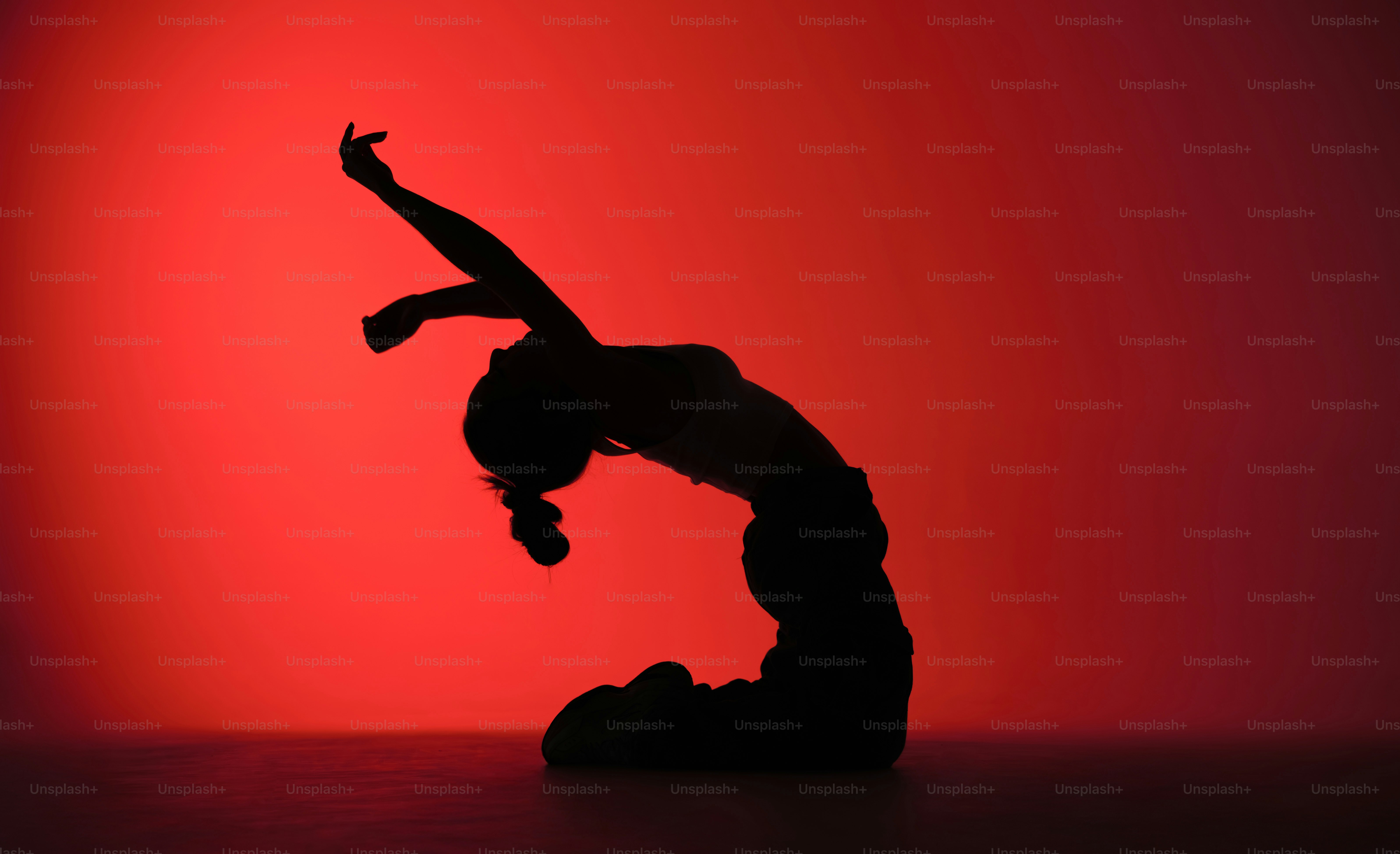 Silhouette of a dancer in a dramatic pose photo – Abstract Image on ...