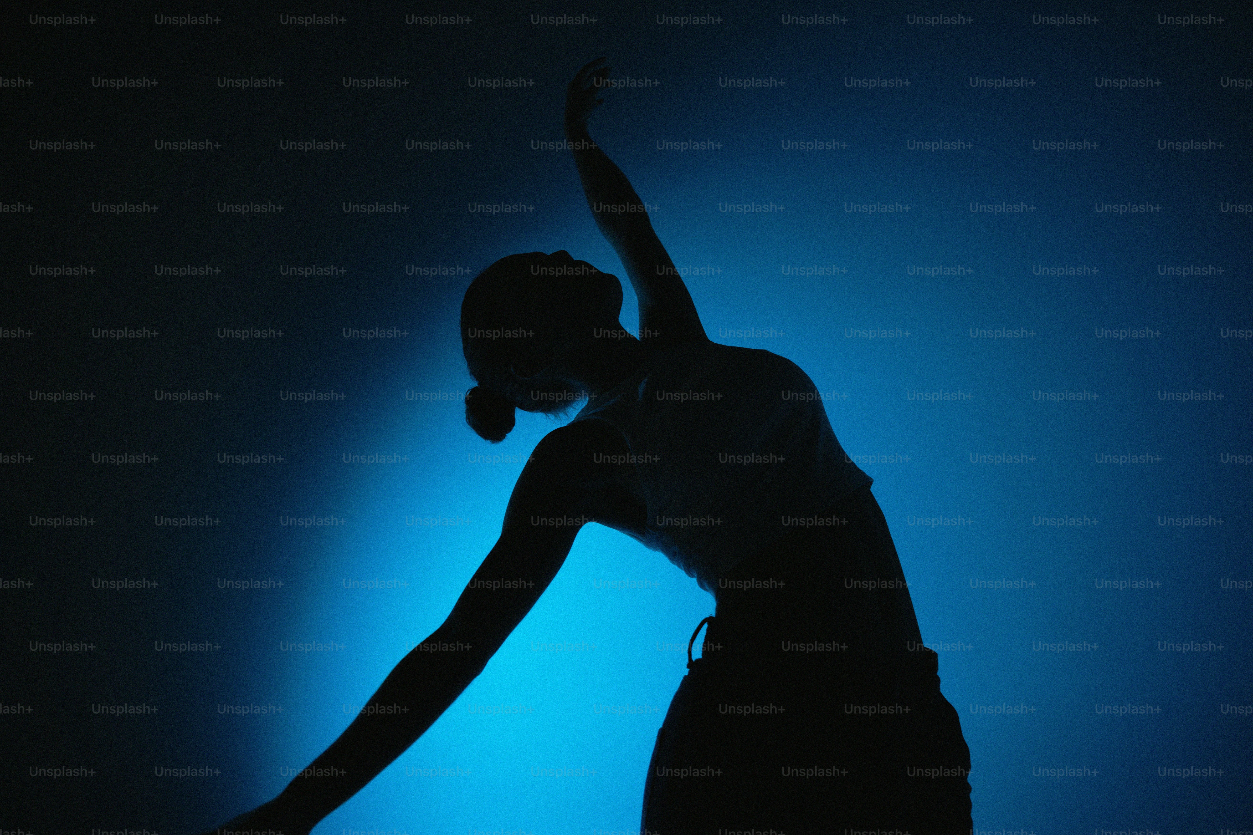 Silhouette of a dancer in a dramatic pose photo – Abstract Image on ...