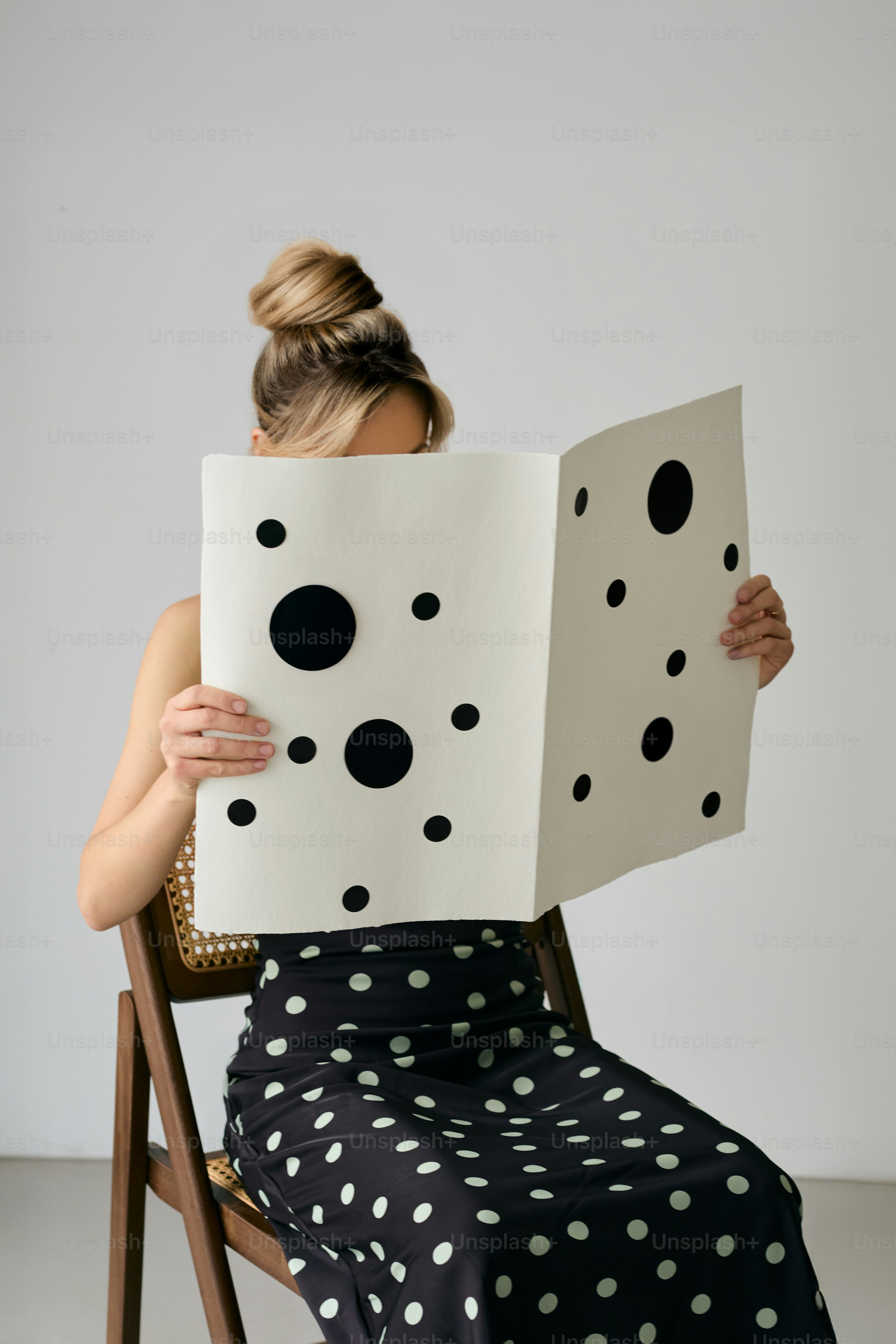 Woman in polka dots holding a spotted paper photo – Patterns Image on ...