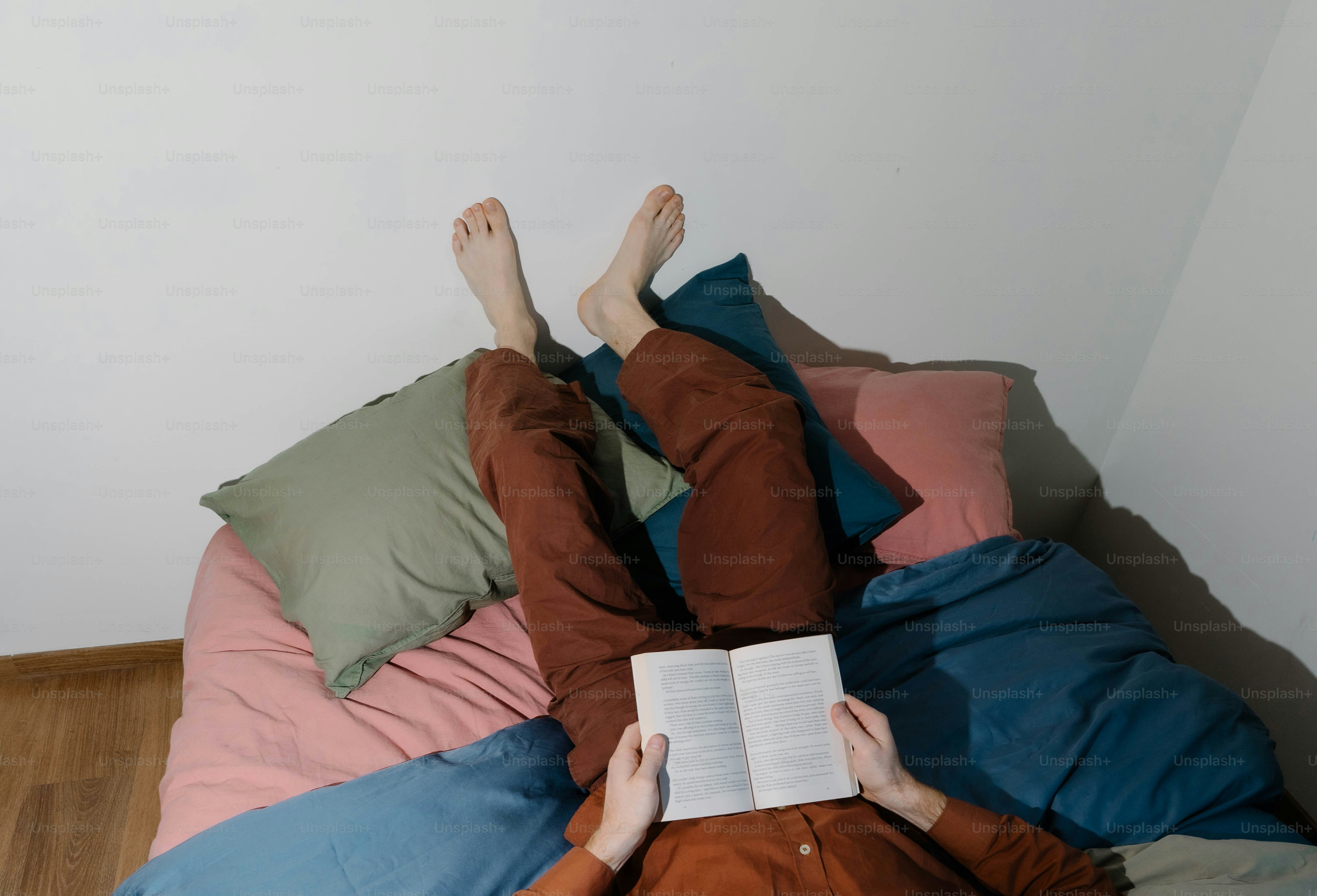 Person reading a book with legs up photo – Book Image on Unsplash