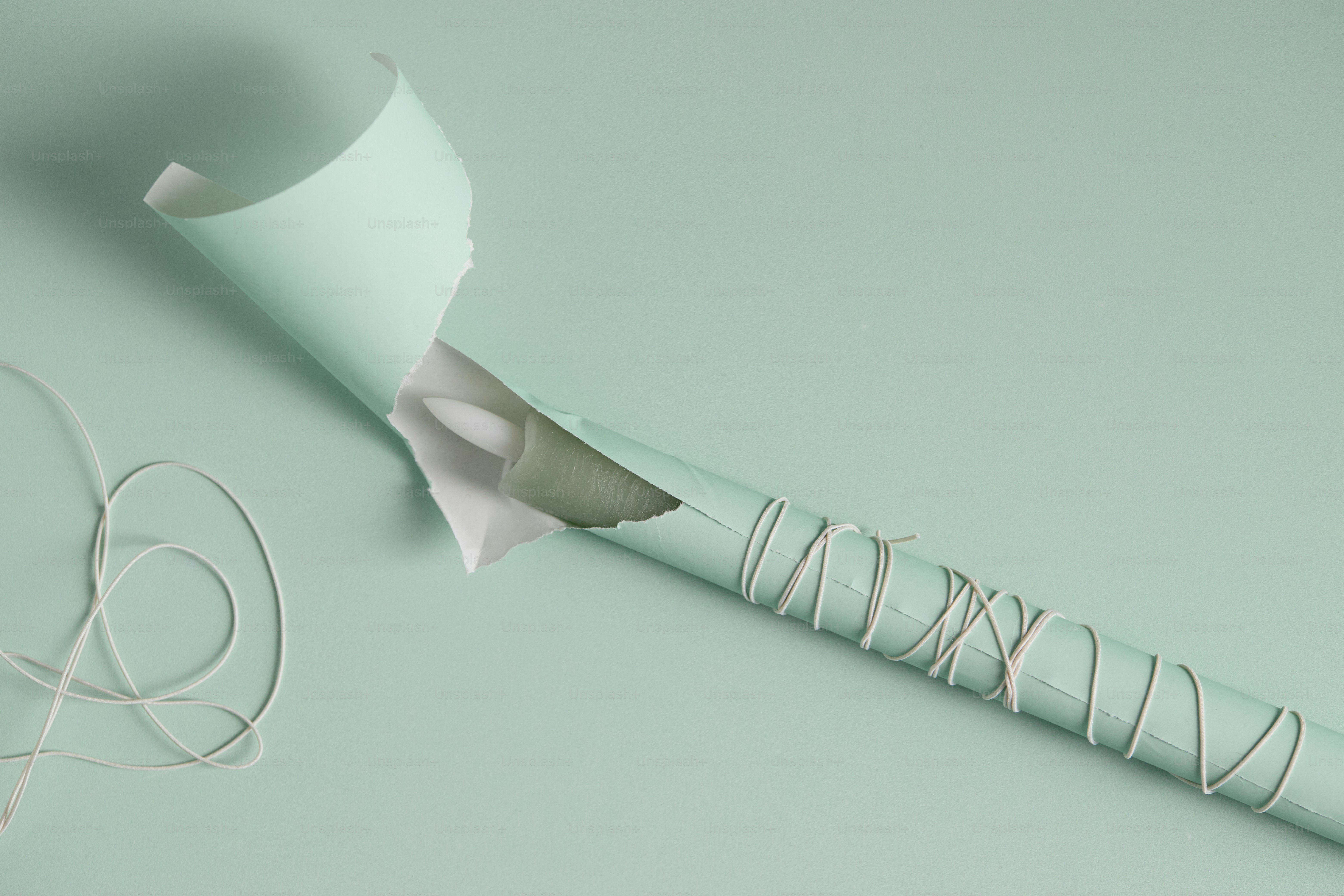 Light blue paper roll with white string photo – Presentation Image on ...