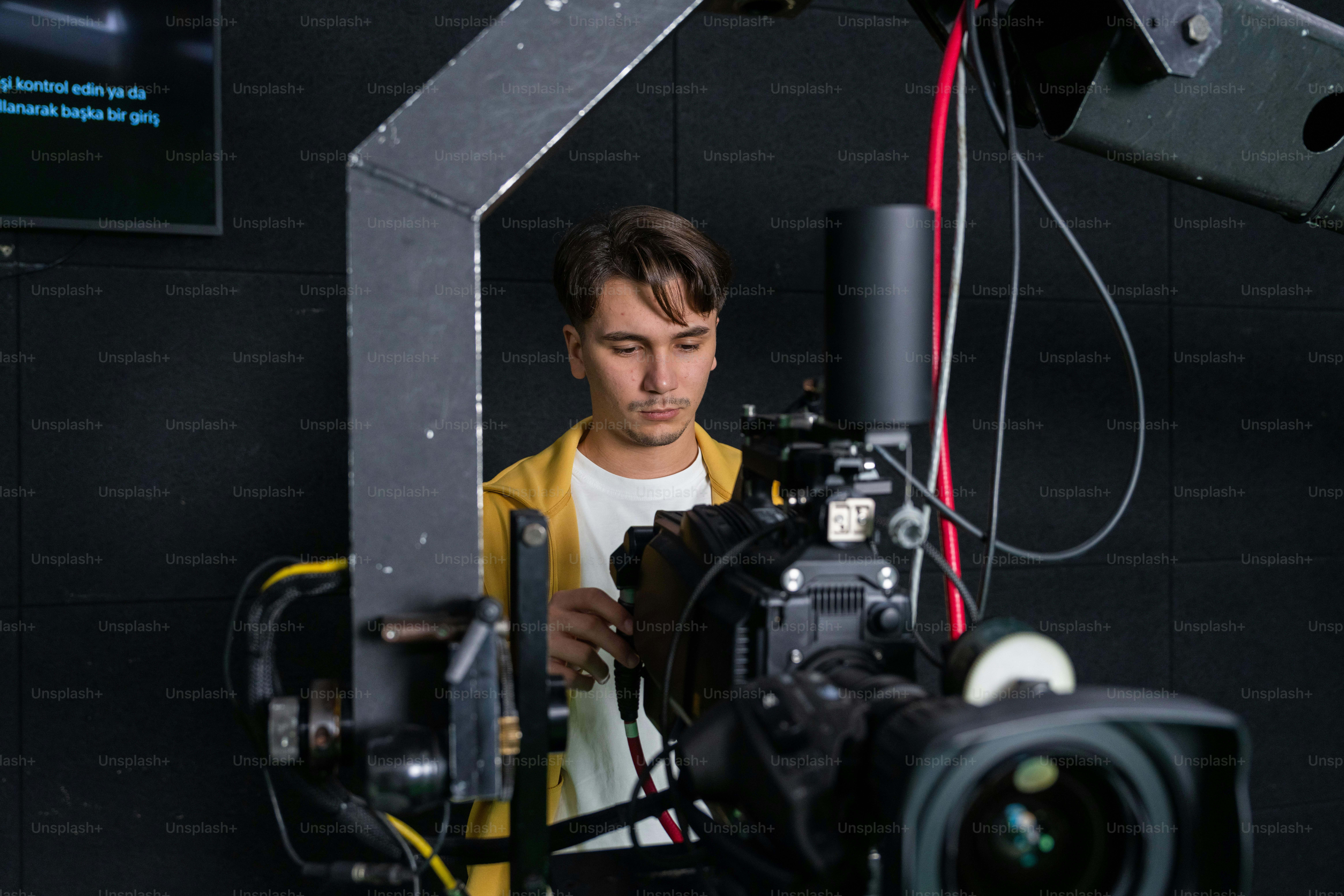 Man adjusting professional video camera equipment photo – Studio Image ...