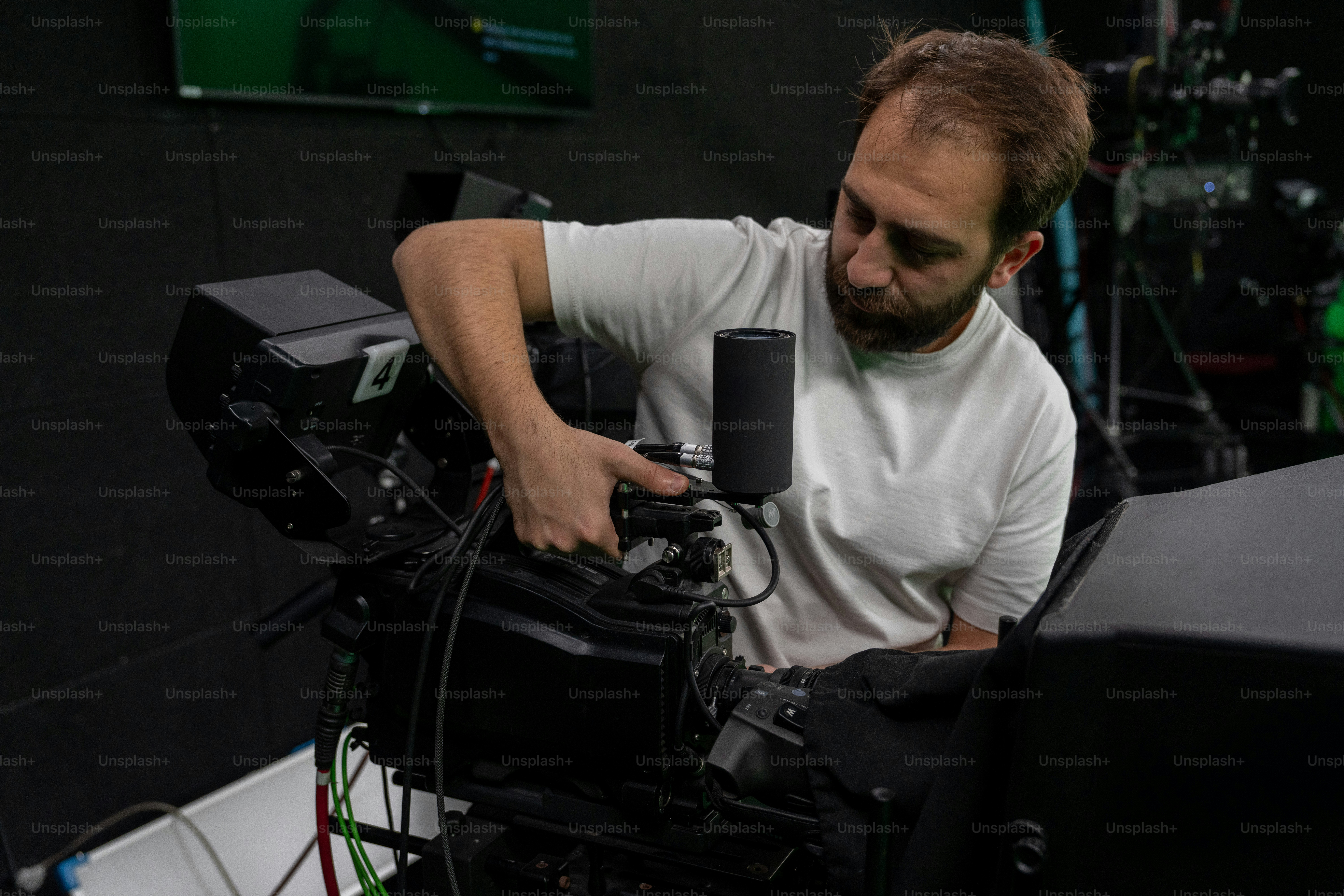 Filmmaker adjusting camera in front of green screen photo – Green Image ...