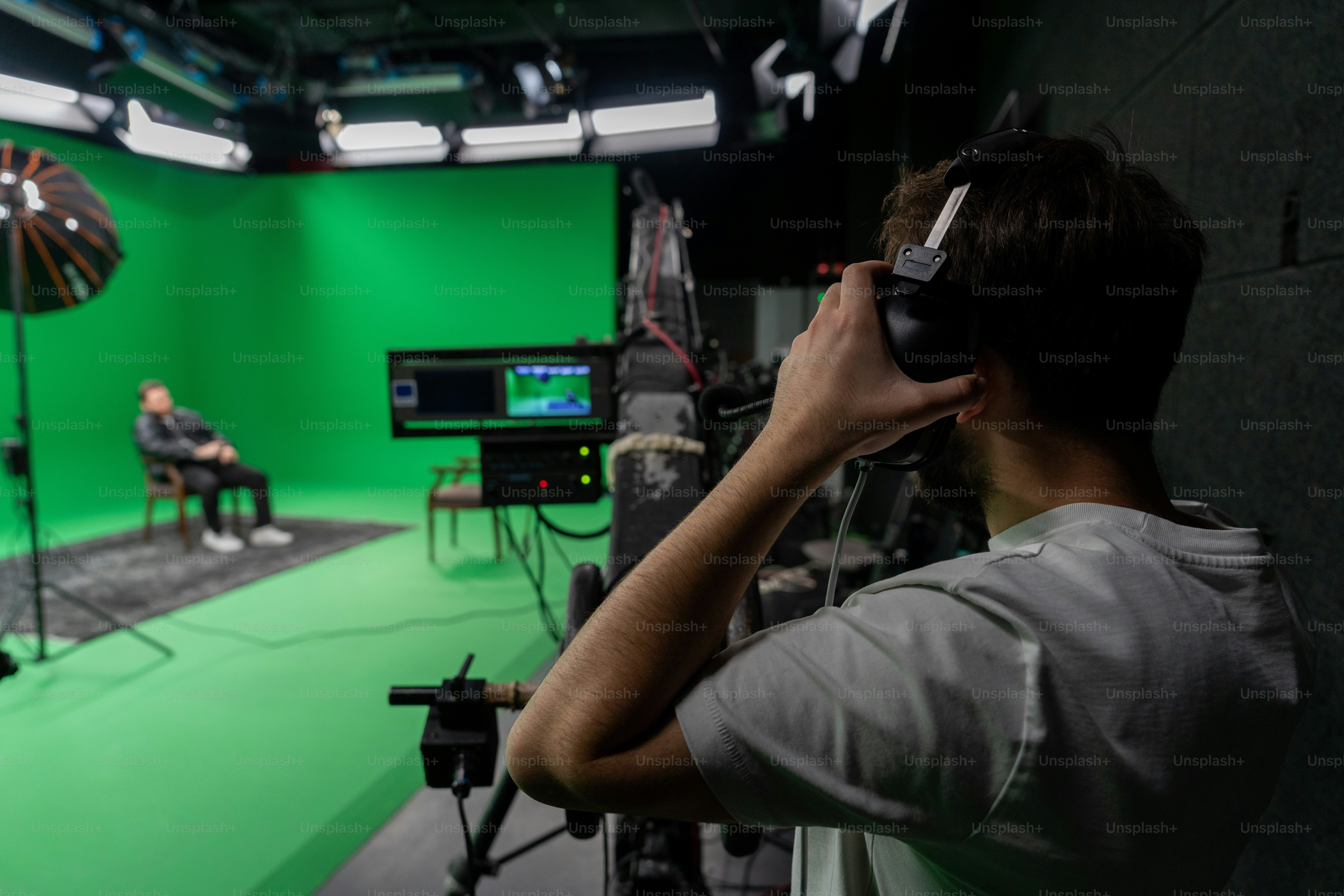 Filmmaker adjusting camera in front of green screen photo – Green Image ...