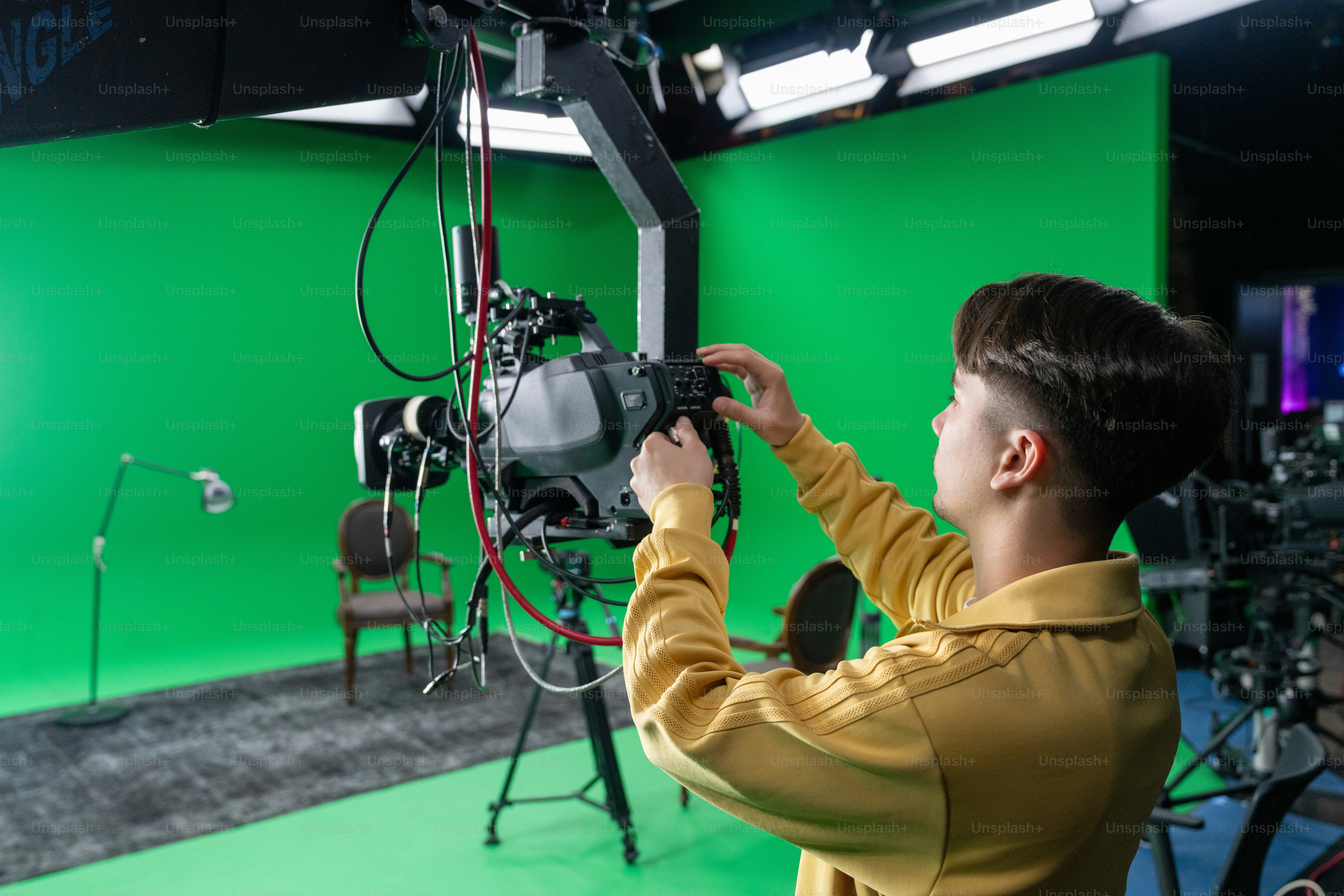 Filmmaker adjusting camera in front of green screen photo – Green Image ...