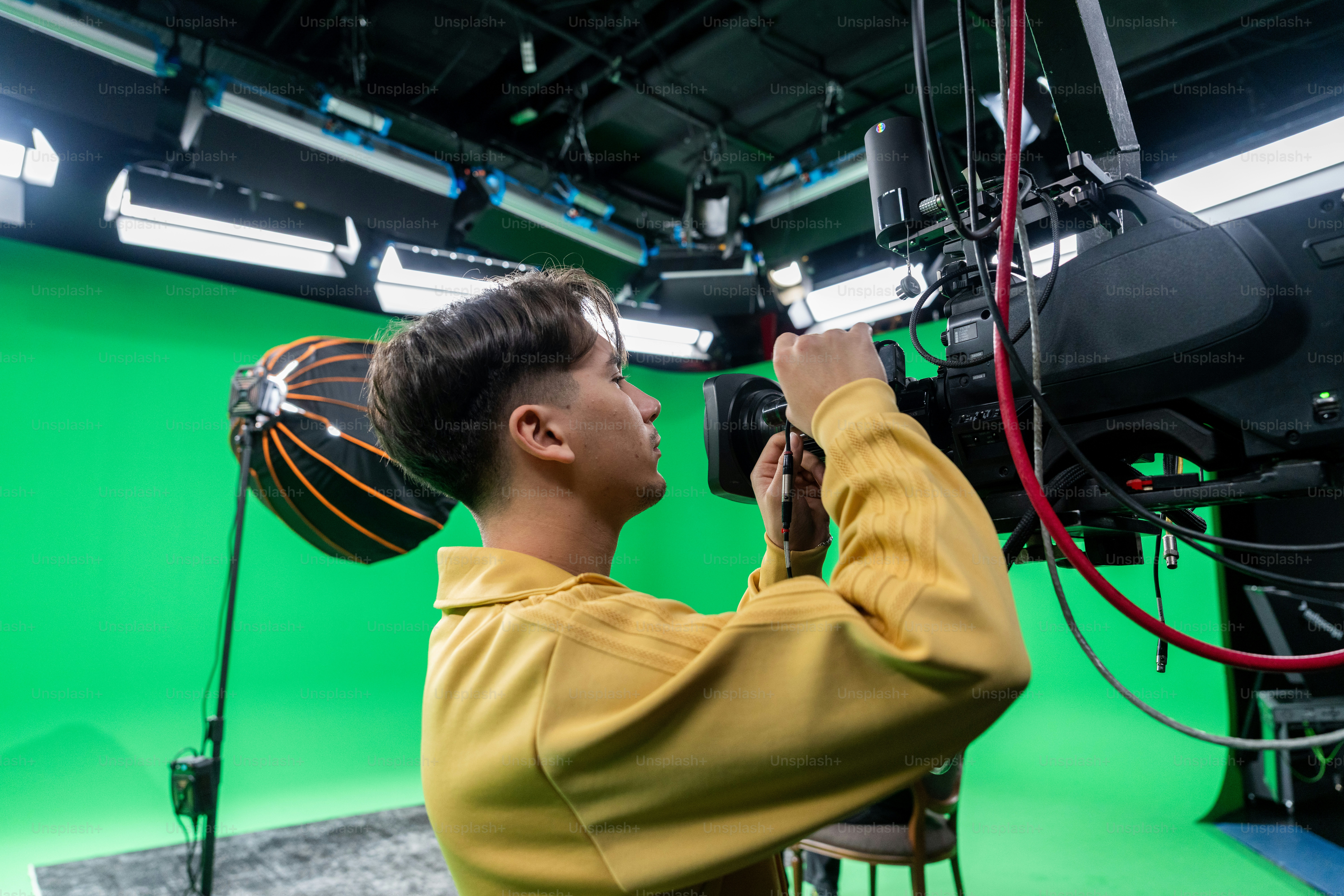 Man working in a television studio with green screen. photo ...