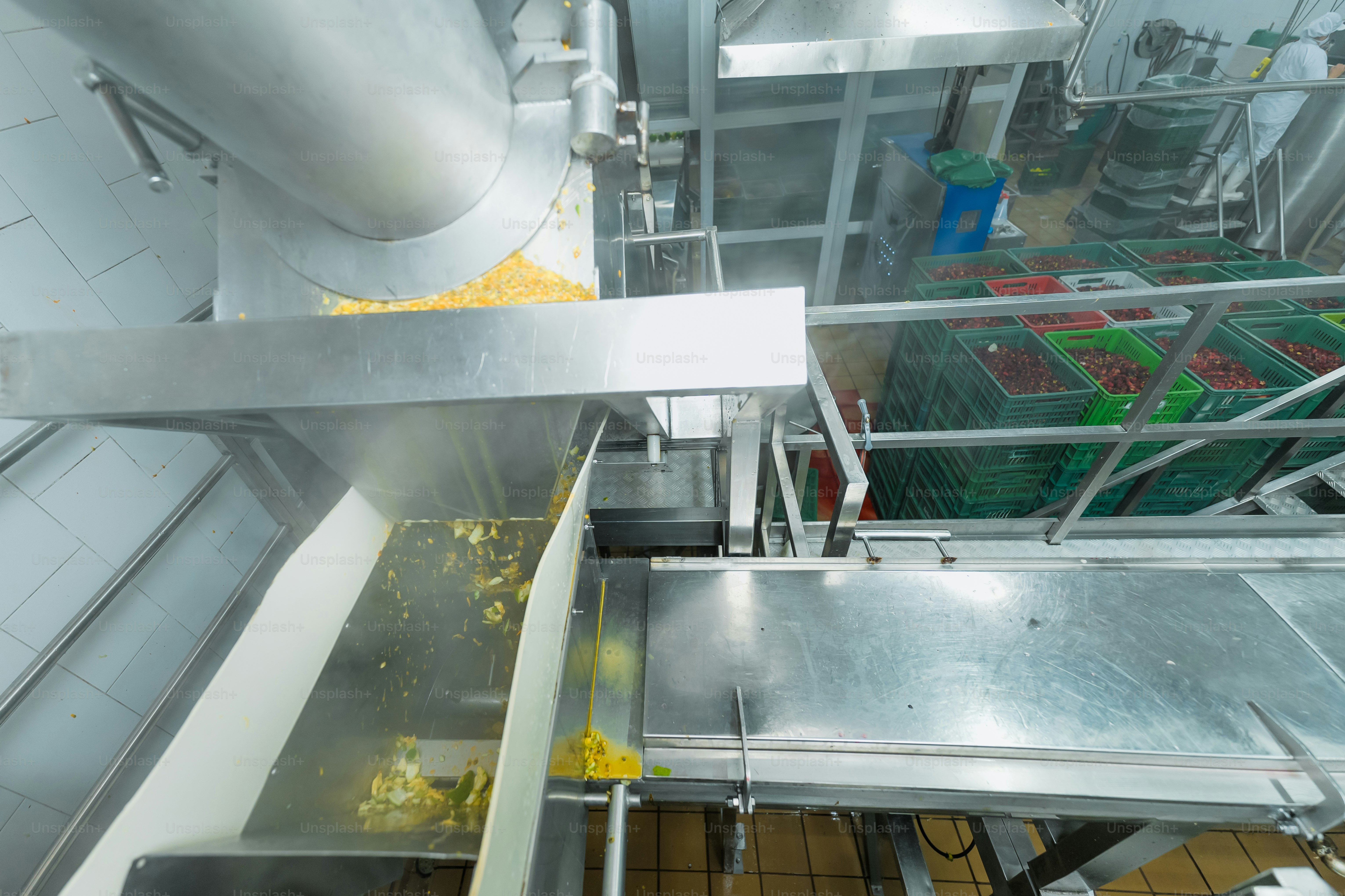 Food processing machinery with yellow ingredients moving ingredients ...