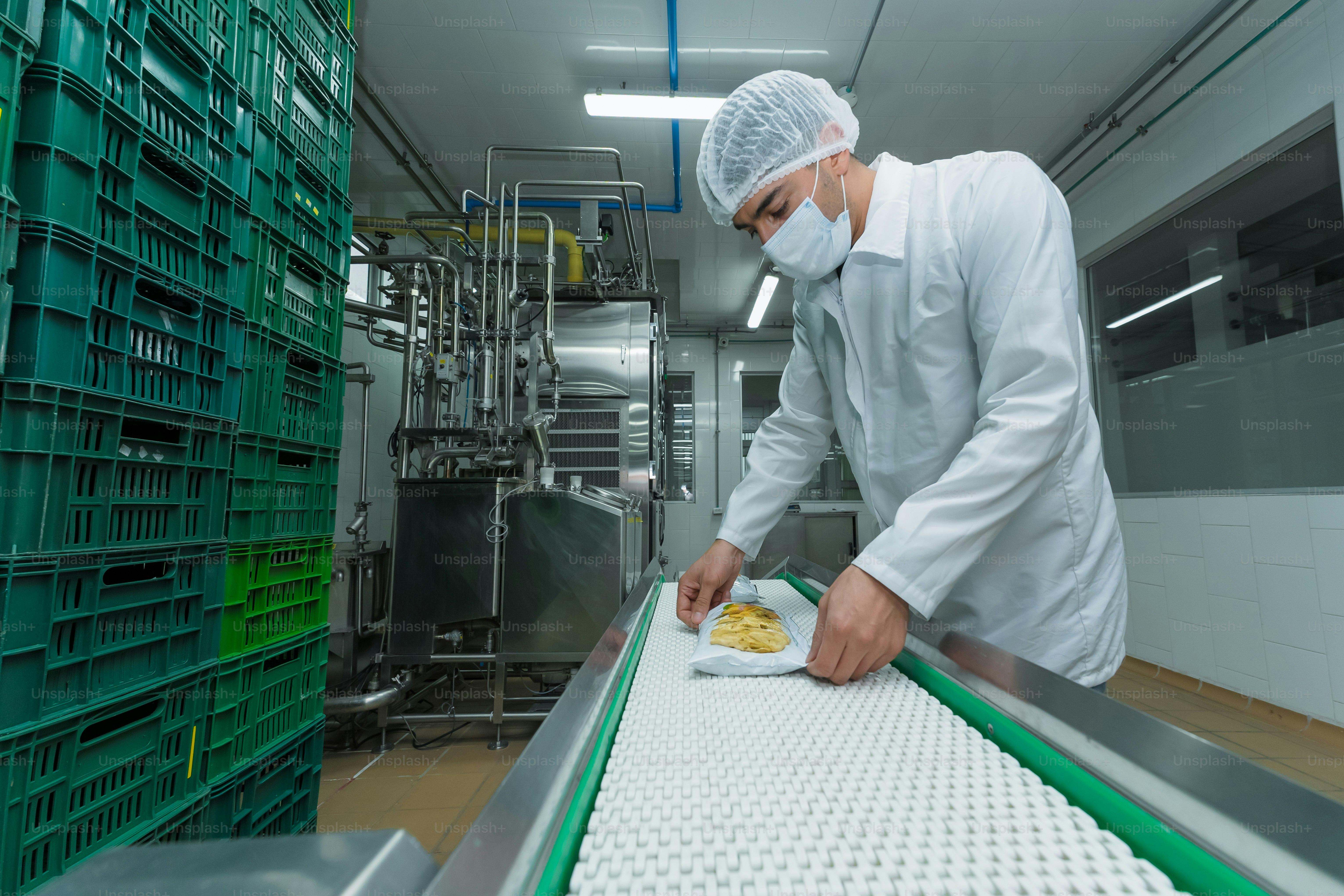 Worker in food processing plant near large stainless steel vat. photo ...