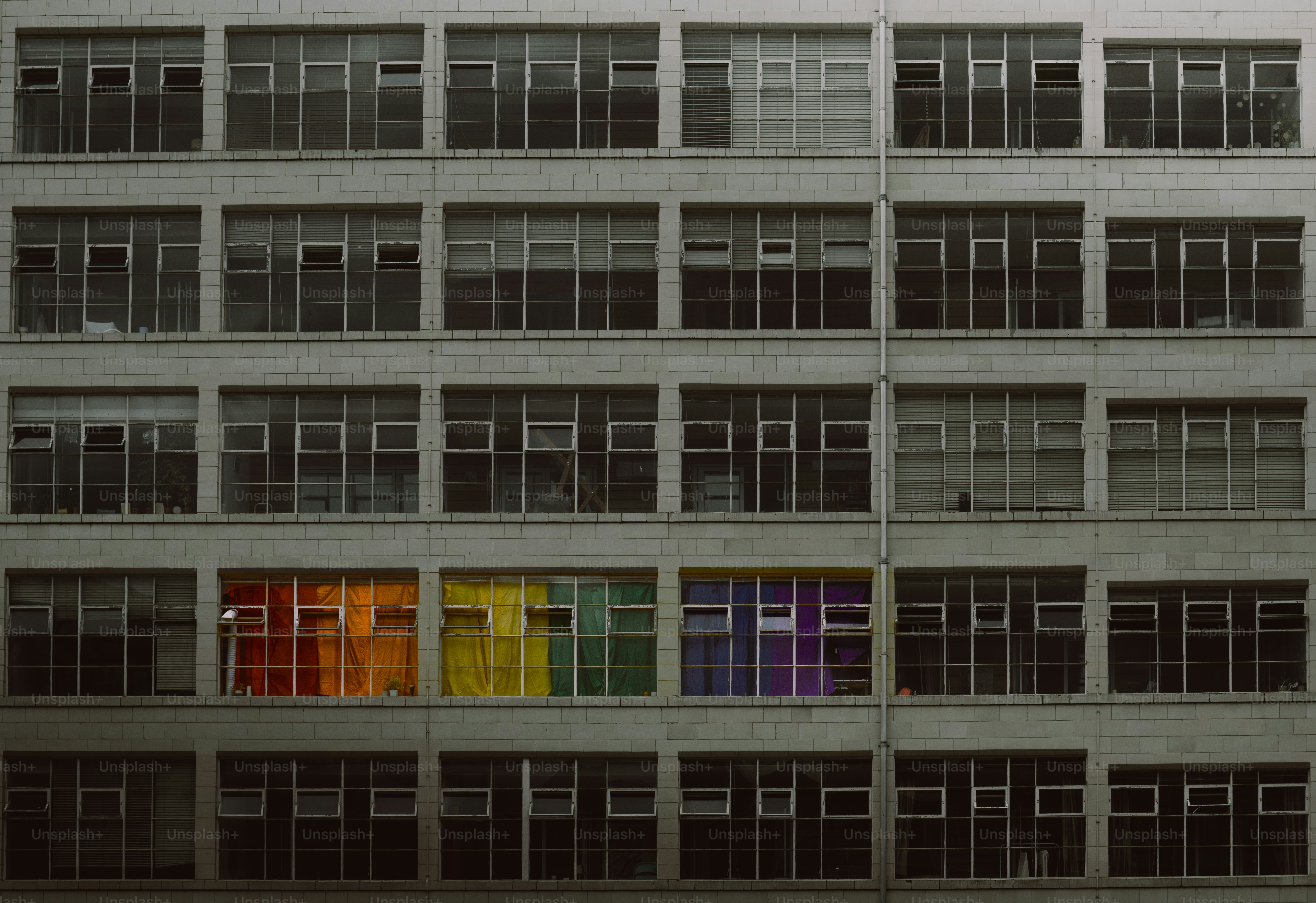 Building facade with rainbow colored windows photo – Building Image on ...
