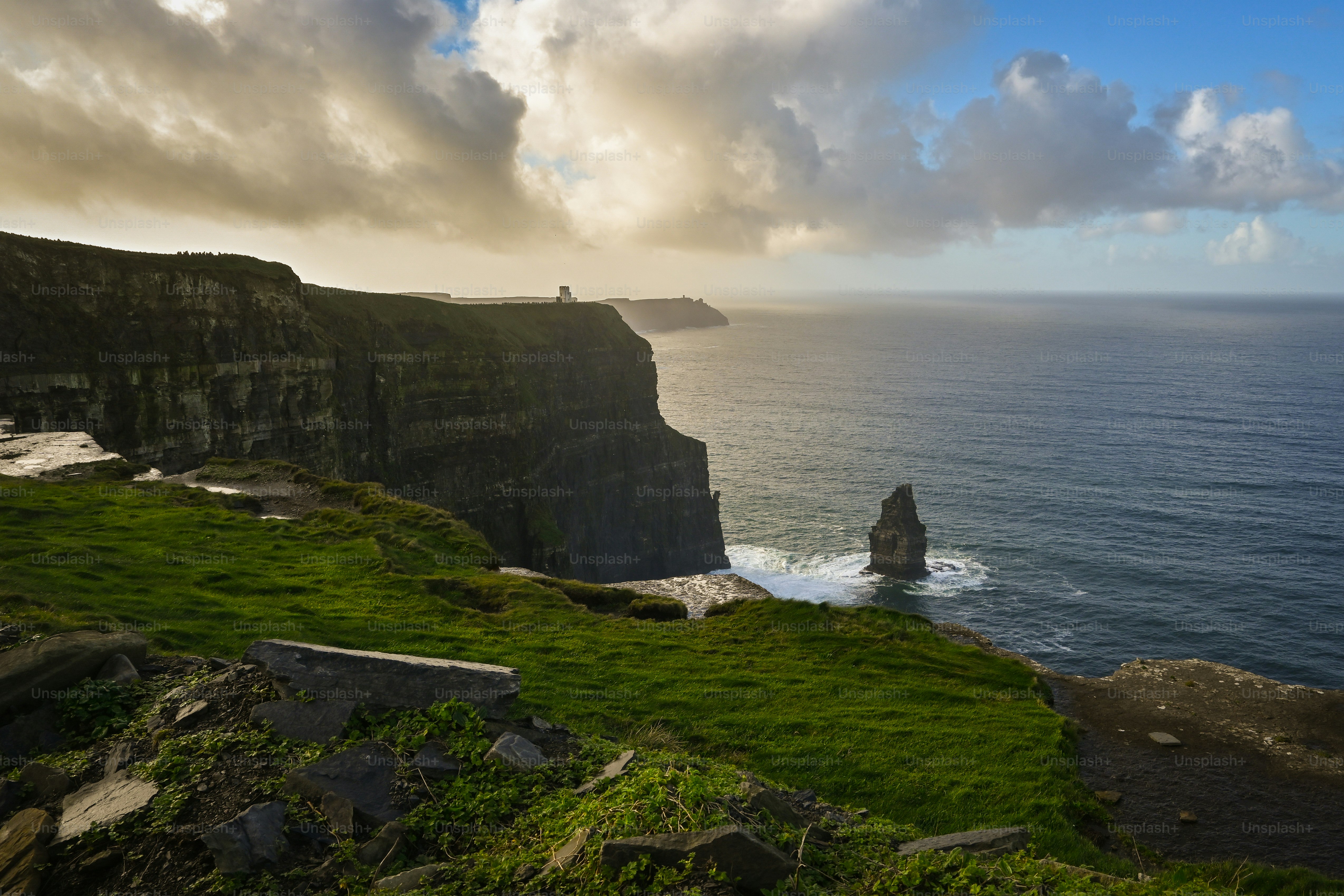 Dramatic cliffs meet the ocean under a cloudy sky. photo – Europe Image ...