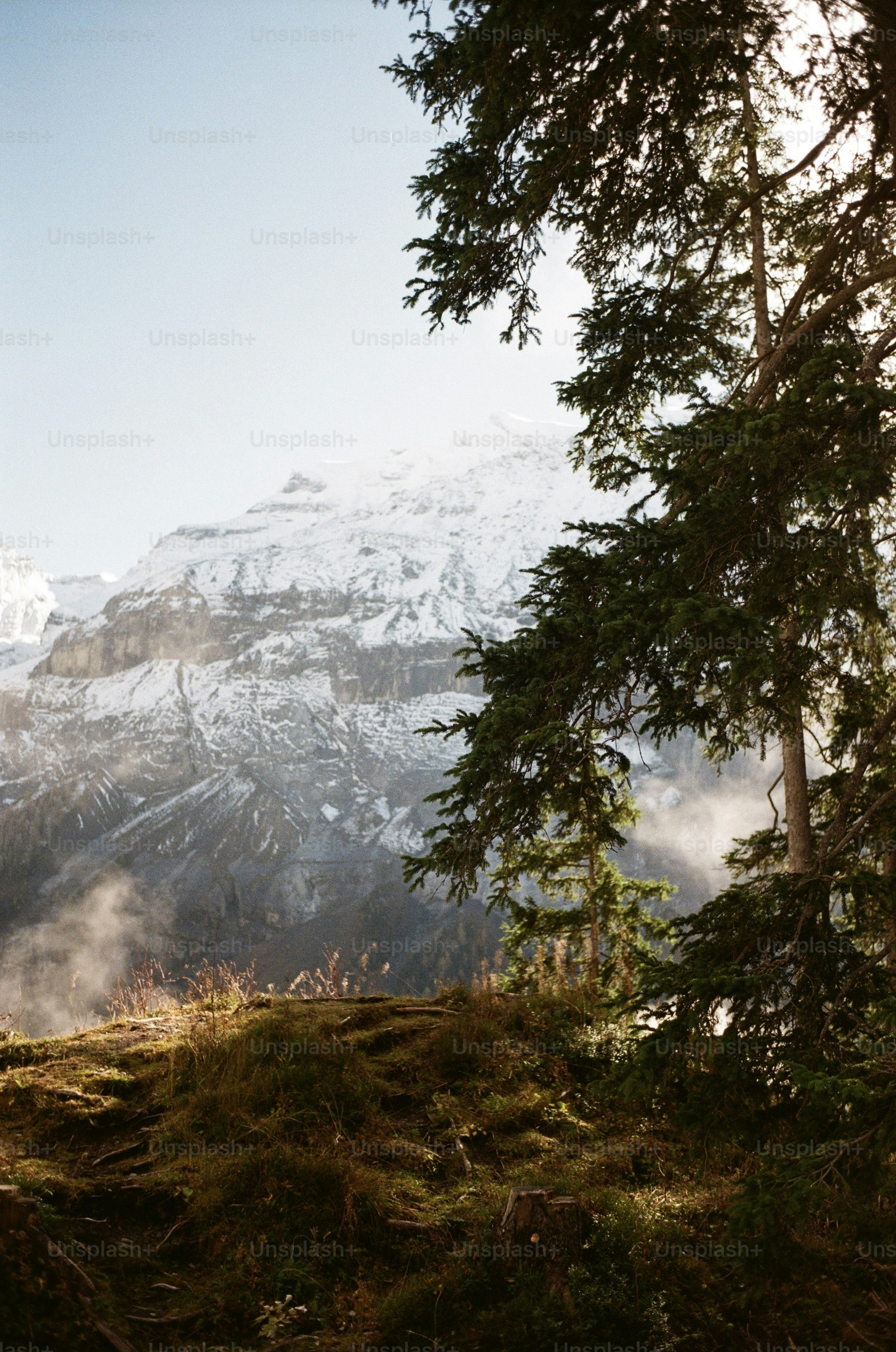 Snow-capped mountains reflected in a clear blue lake. photo – Lake ...