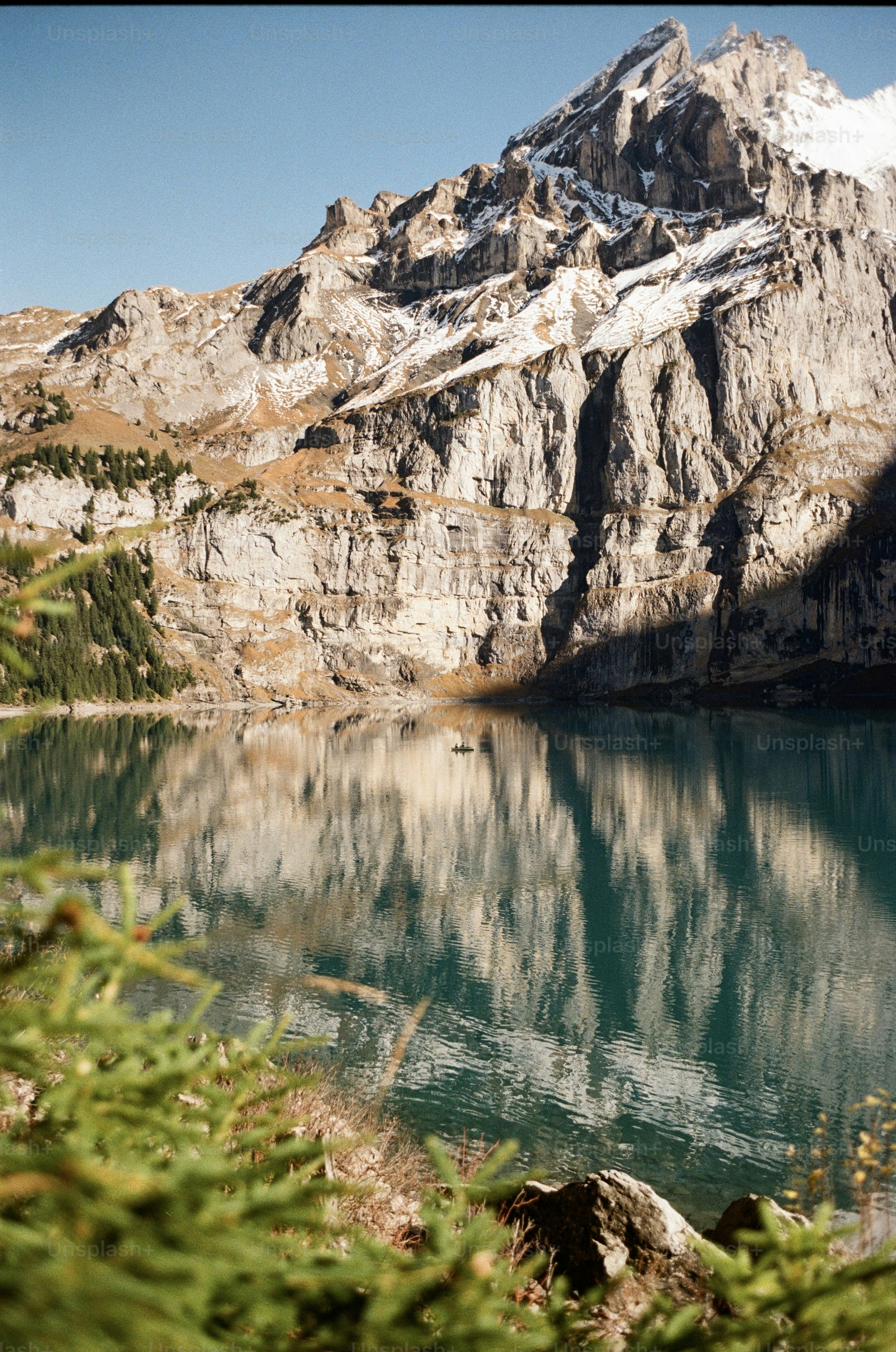 Snow-capped mountains reflected in a clear blue lake. photo – Lake ...