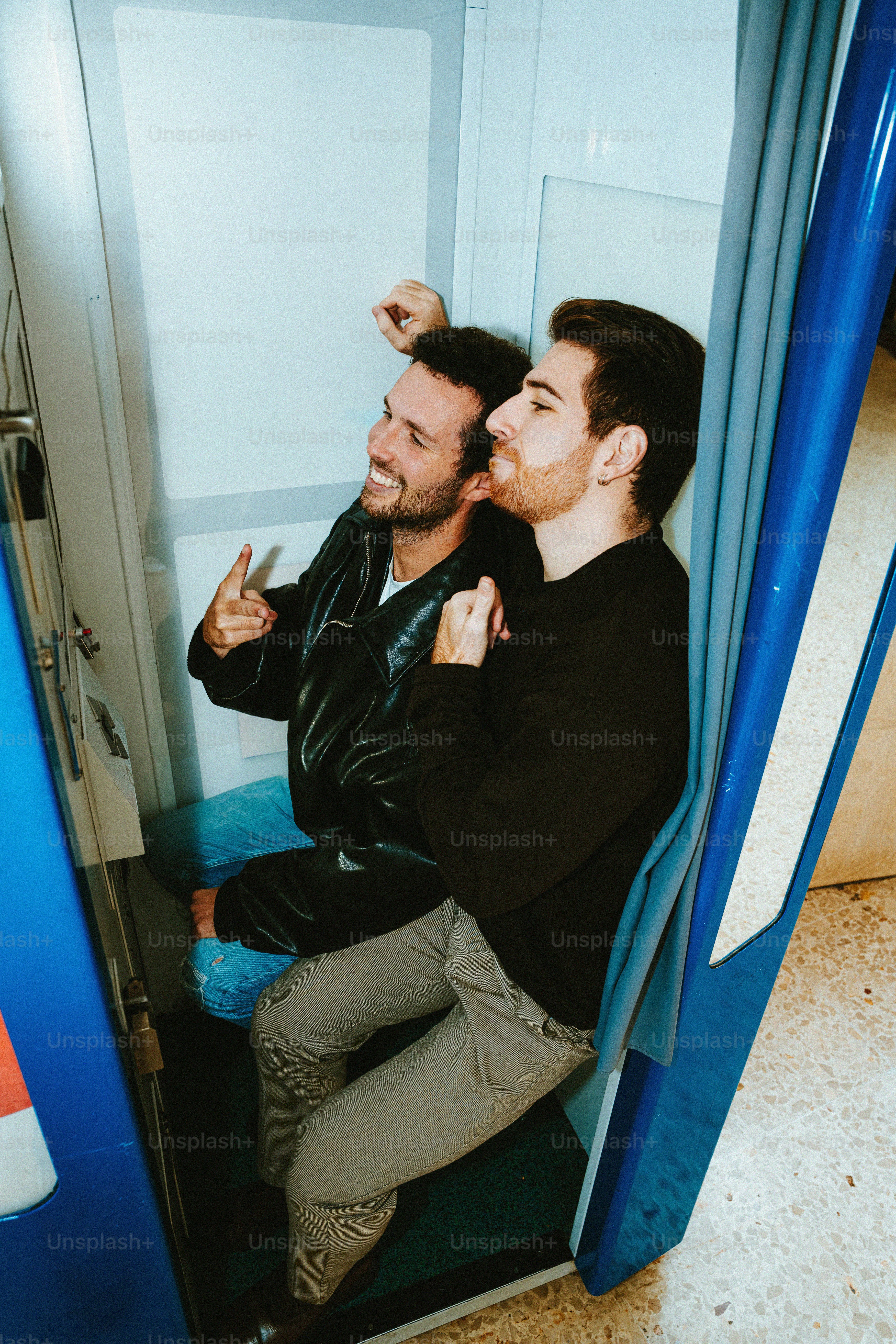 Man standing next to a fotomaton booth photo – Image on Unsplash