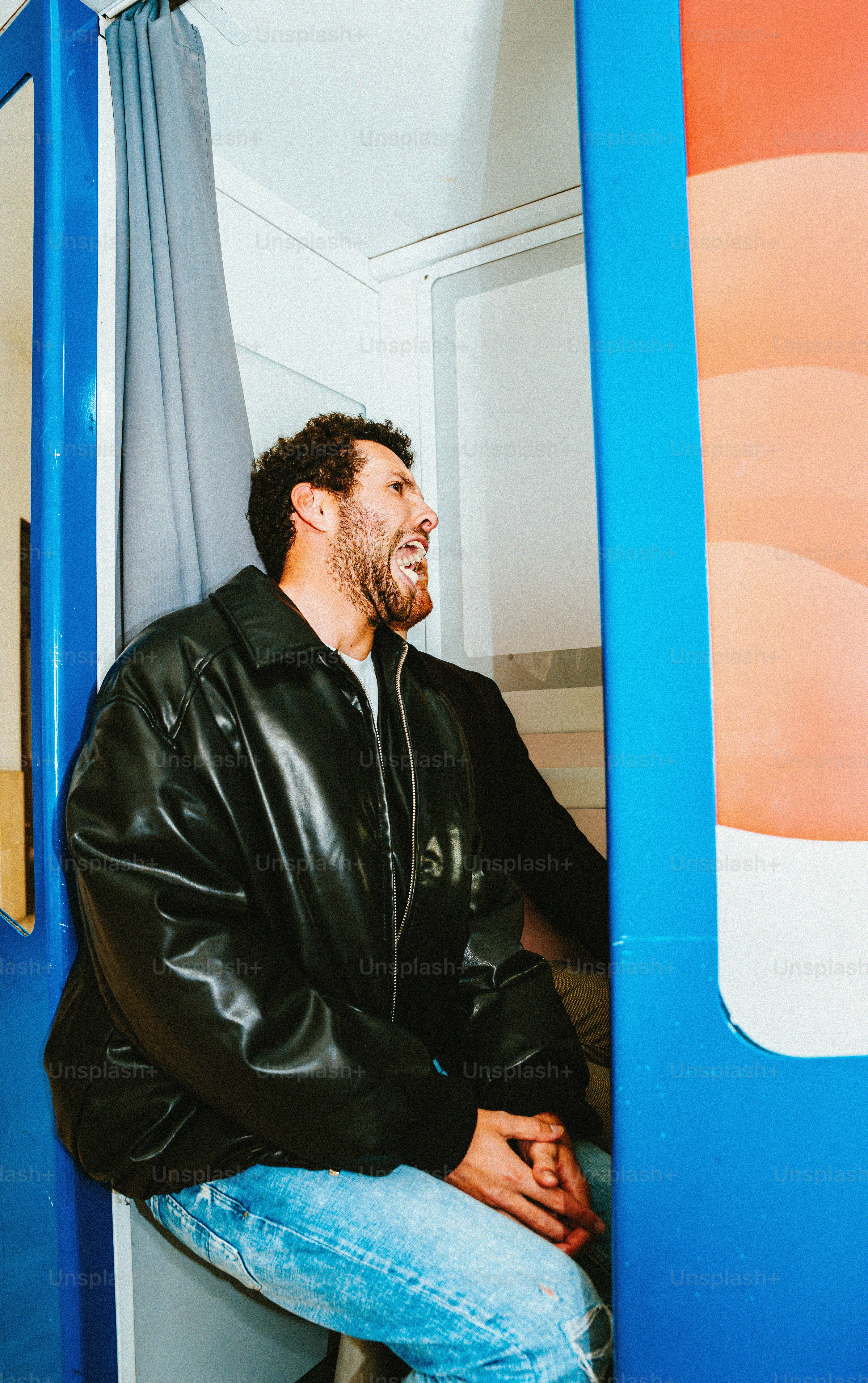 Man in leather jacket and jeans in photo booth. photo – Man Image on ...