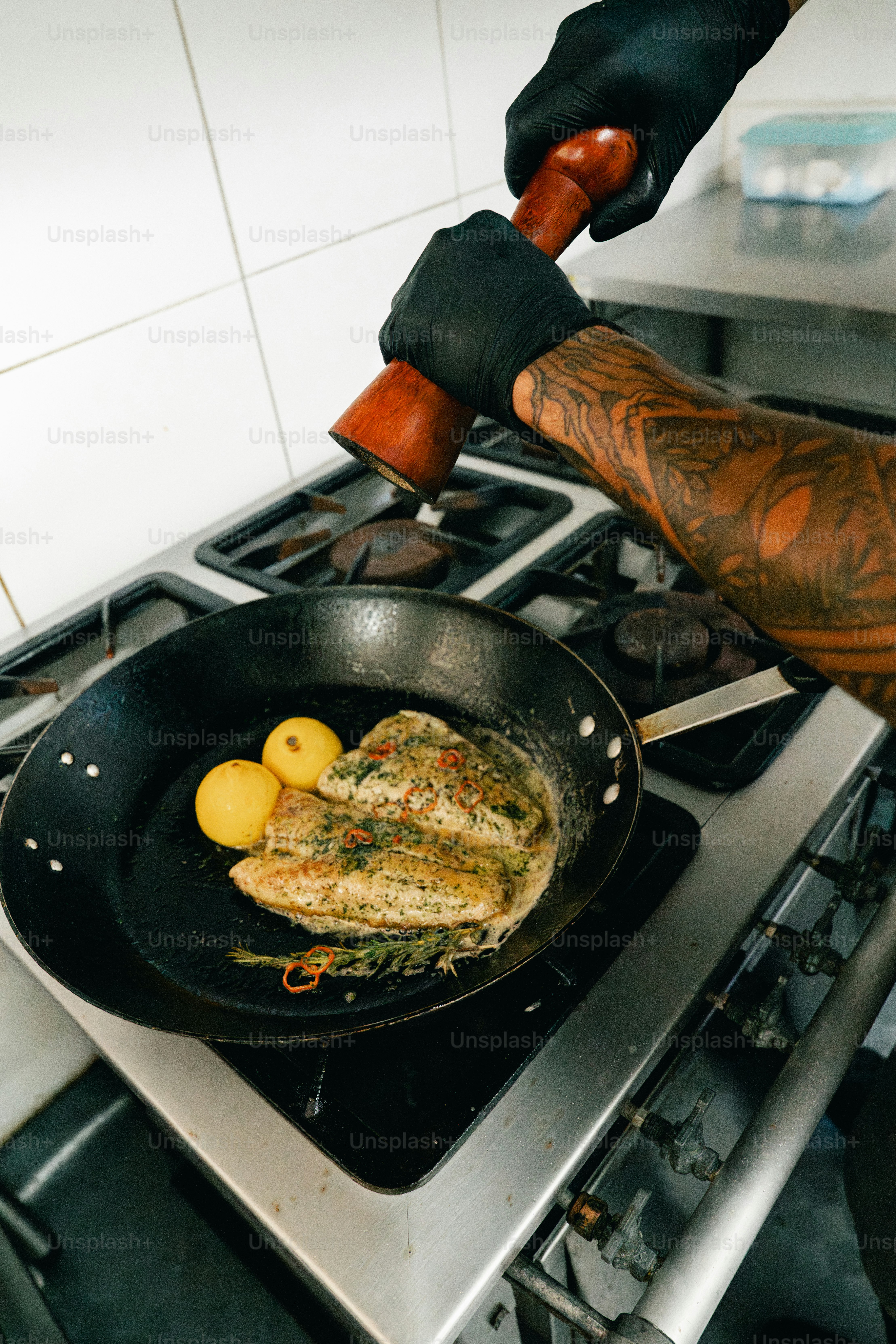 Chef seasons fish cooking in a pan photo – Food Image on Unsplash