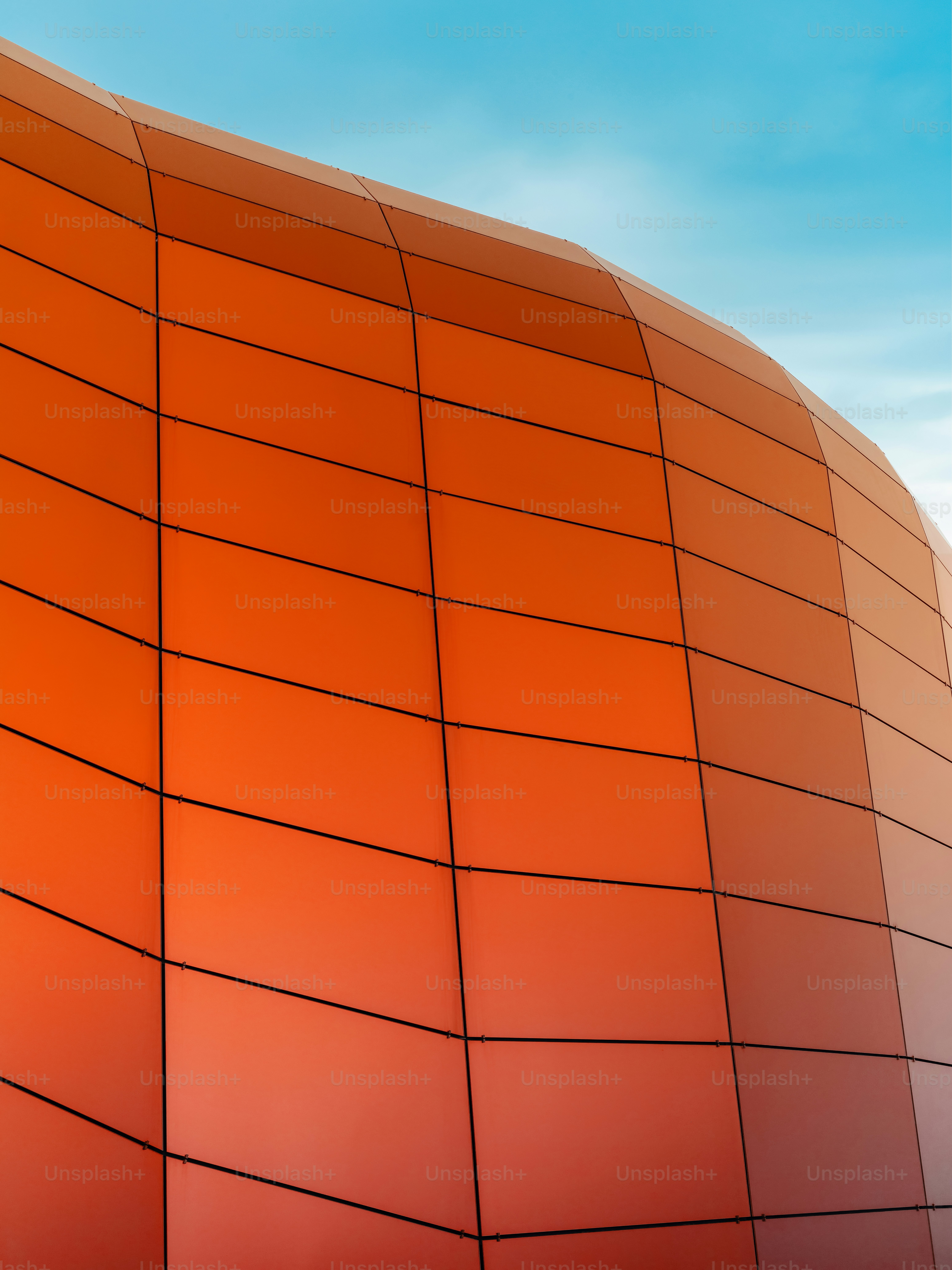 Orange building facade against a blue sky photo – Abstract background ...