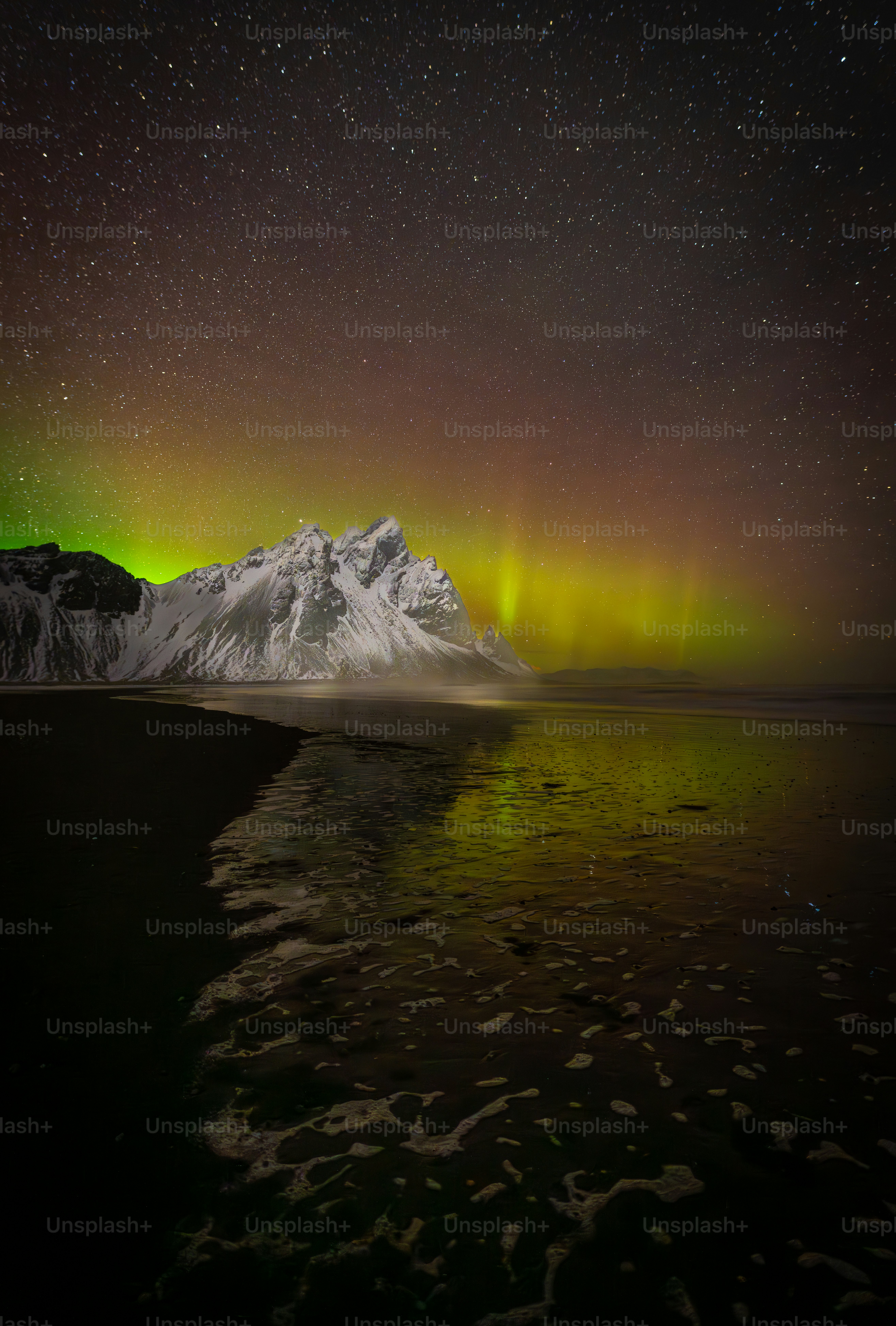 Aurora borealis over a snowy mountain and ocean. photo – Winter Image ...