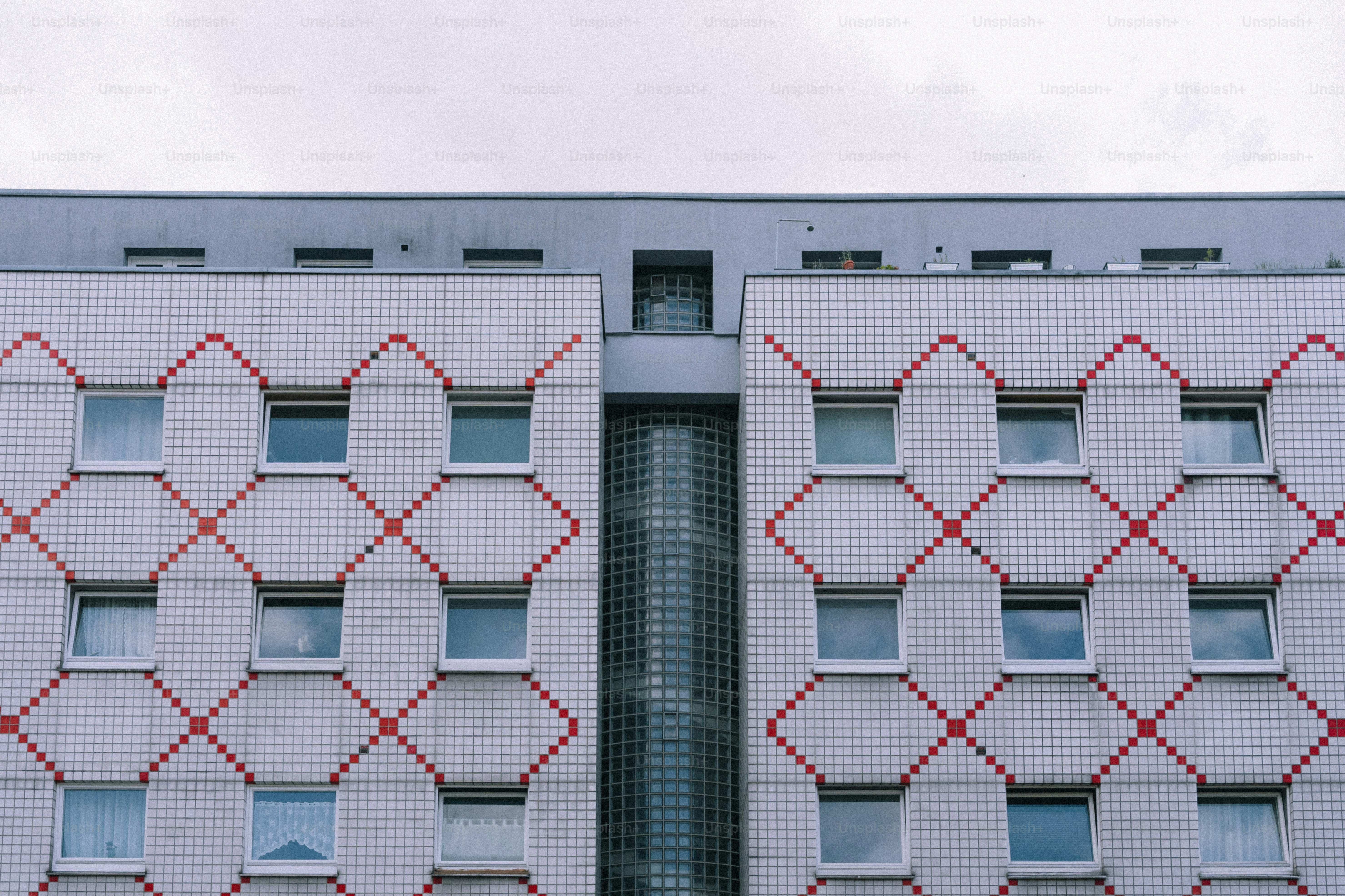 Modern building facade with geometric red tile pattern. photo – City ...