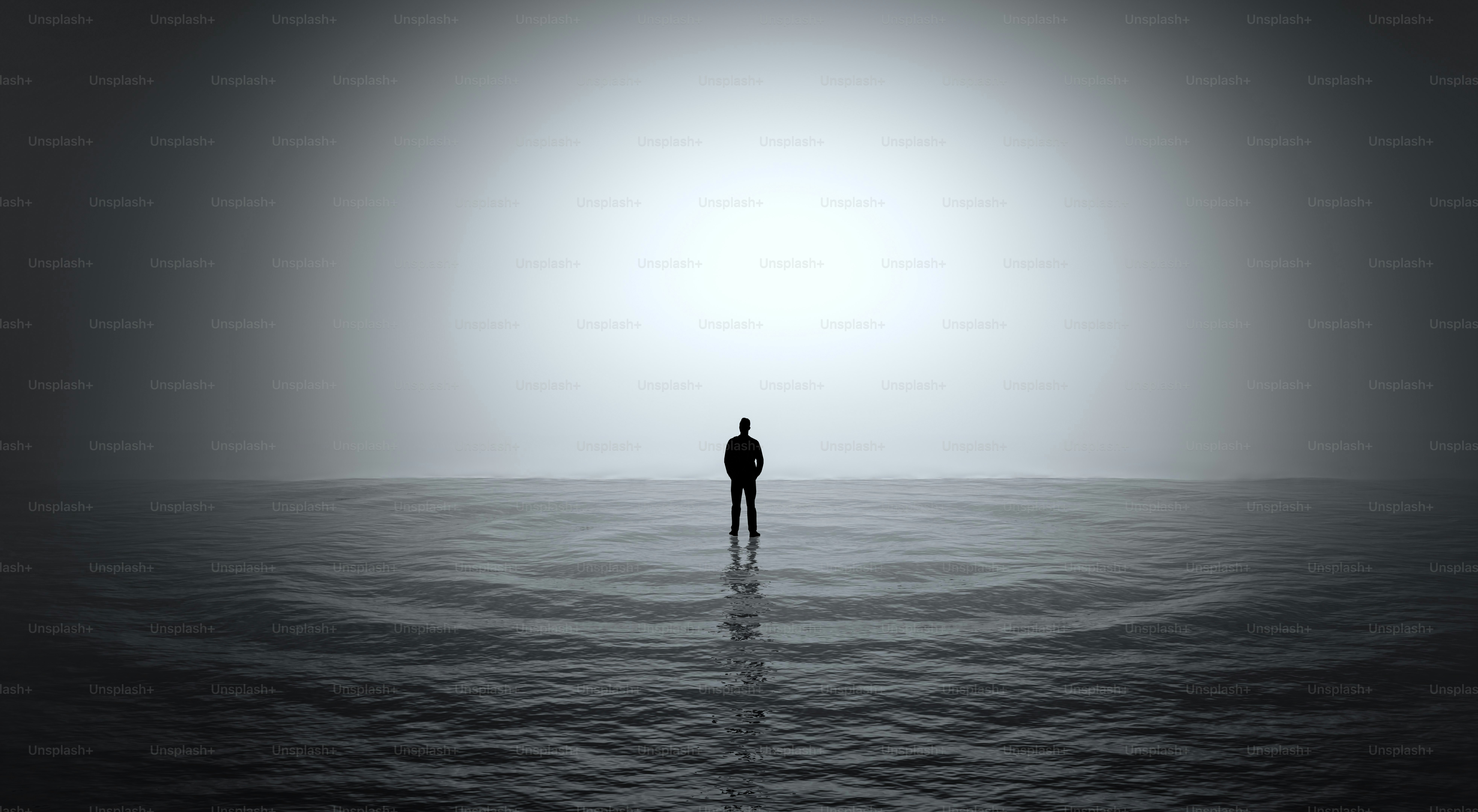 Man standing alone in vast, misty ocean expanse photo – Image on Unsplash