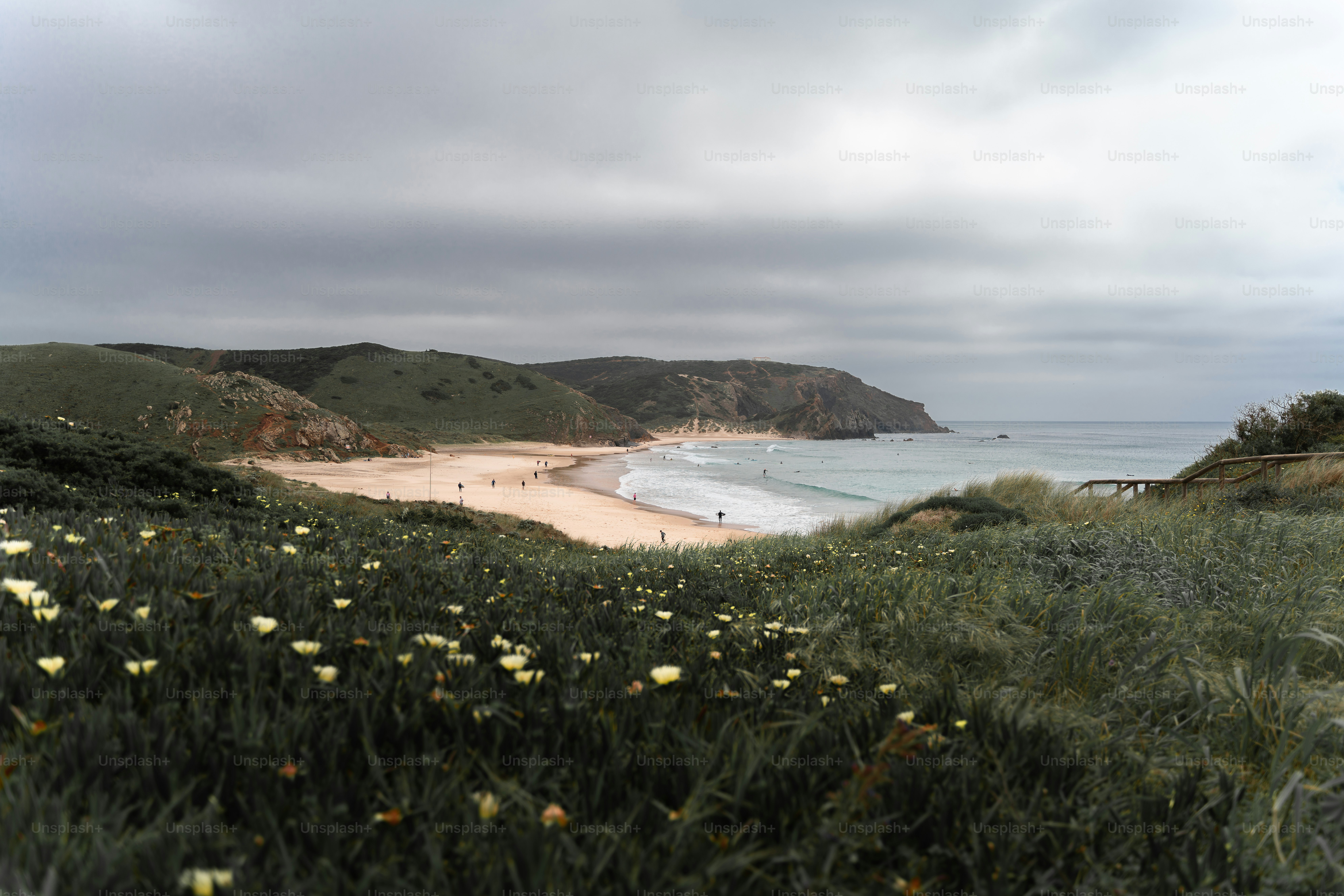Rocky coastline with crashing waves and a sandy cove. photo – Beach ...