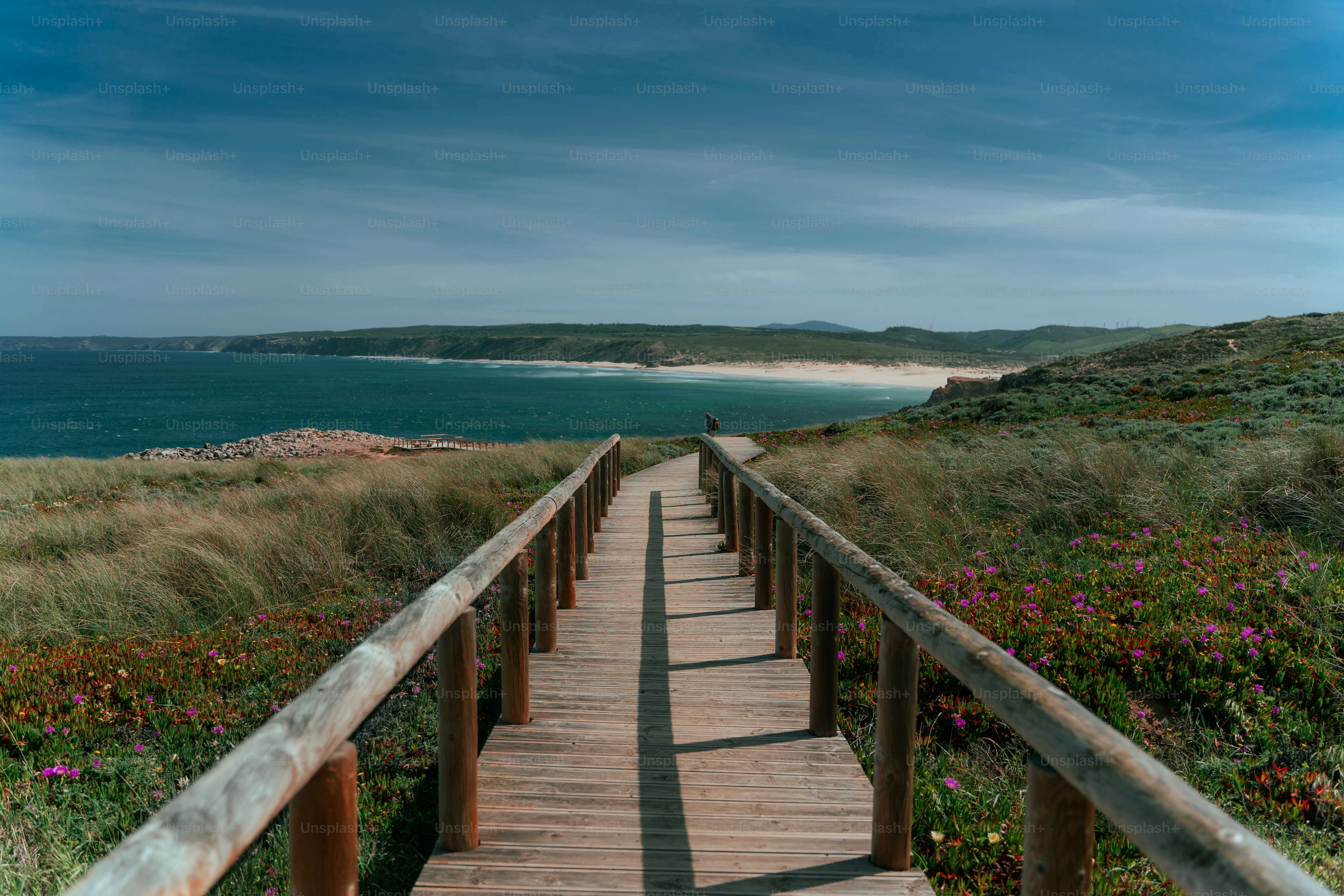 Rocky coastline with crashing waves and a sandy cove. photo – Beach ...