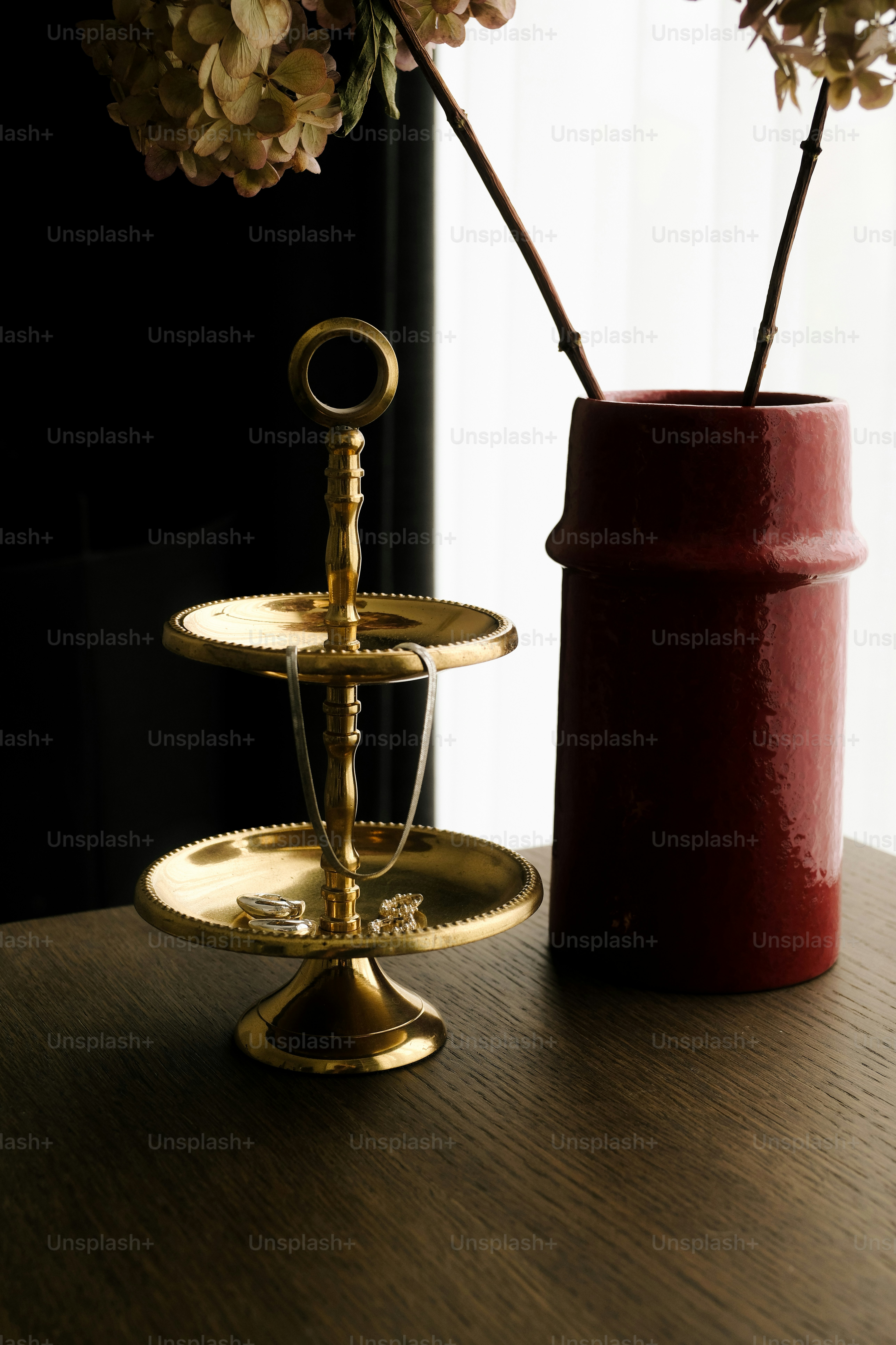 Two-tiered gold jewelry stand with vase photo – Image on Unsplash