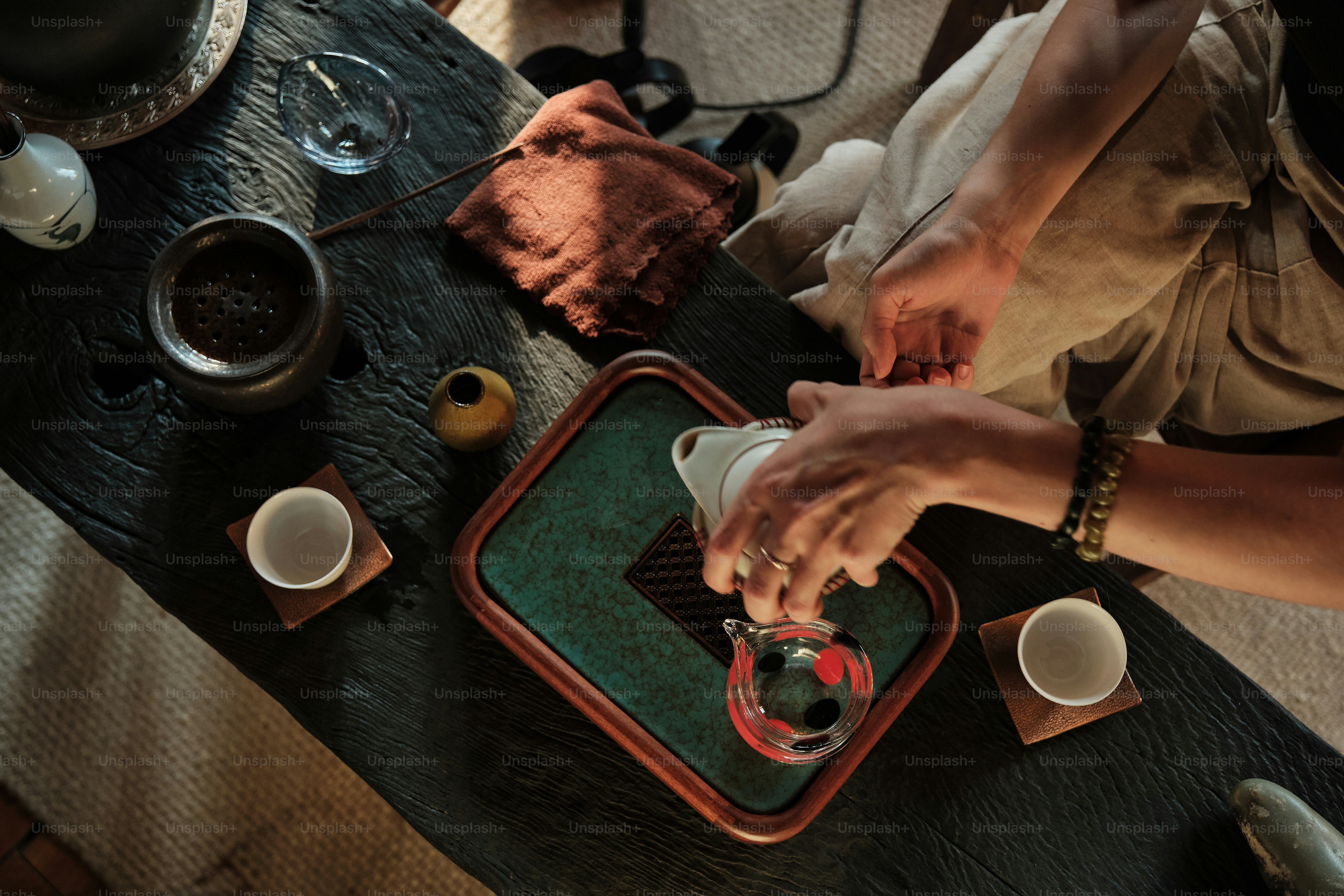Person pouring tea during a traditional ceremony. photo – Tea Image on ...