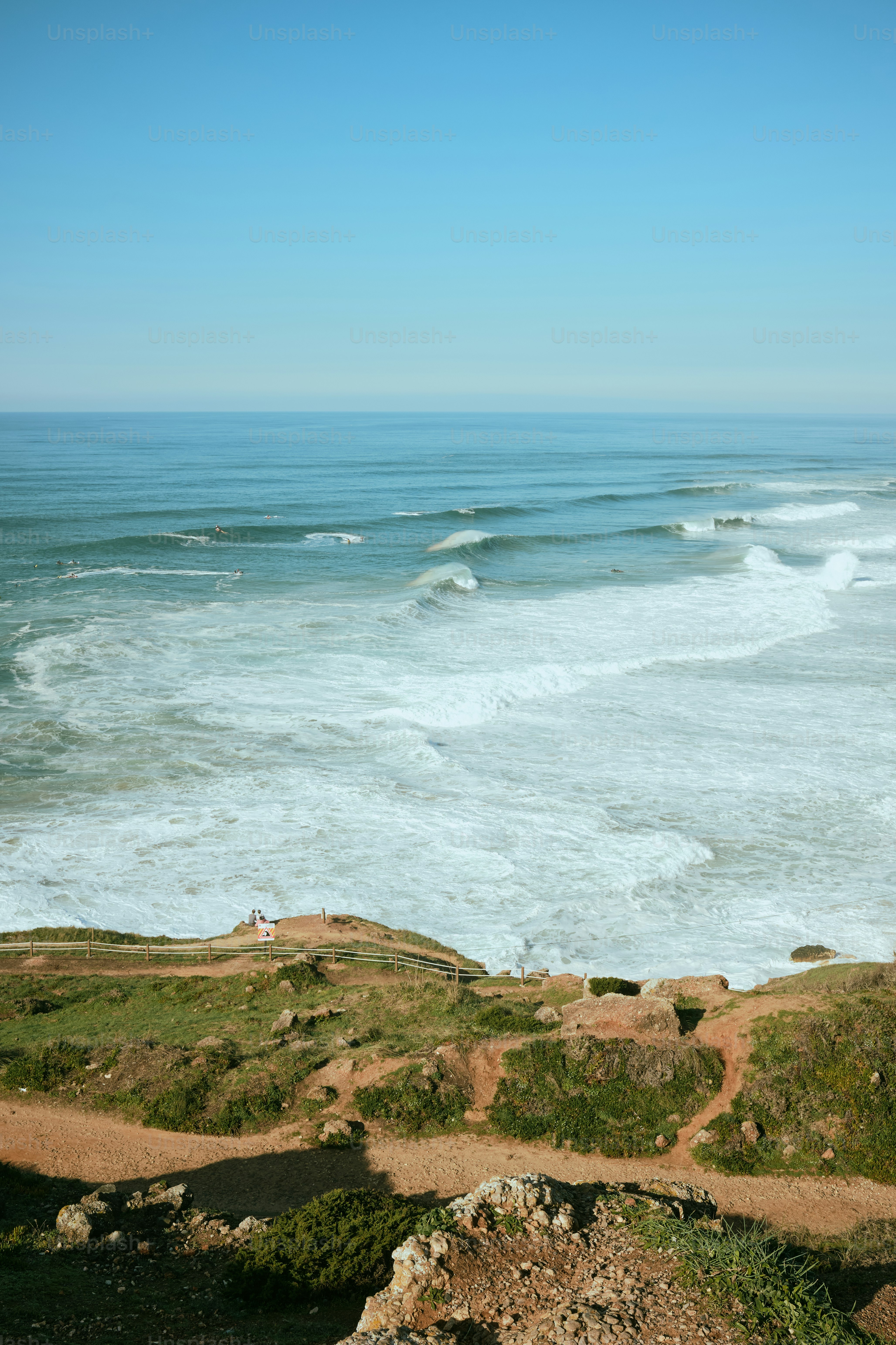 Olas rompiendo en una playa de arena bajo un cielo despejado foto ...