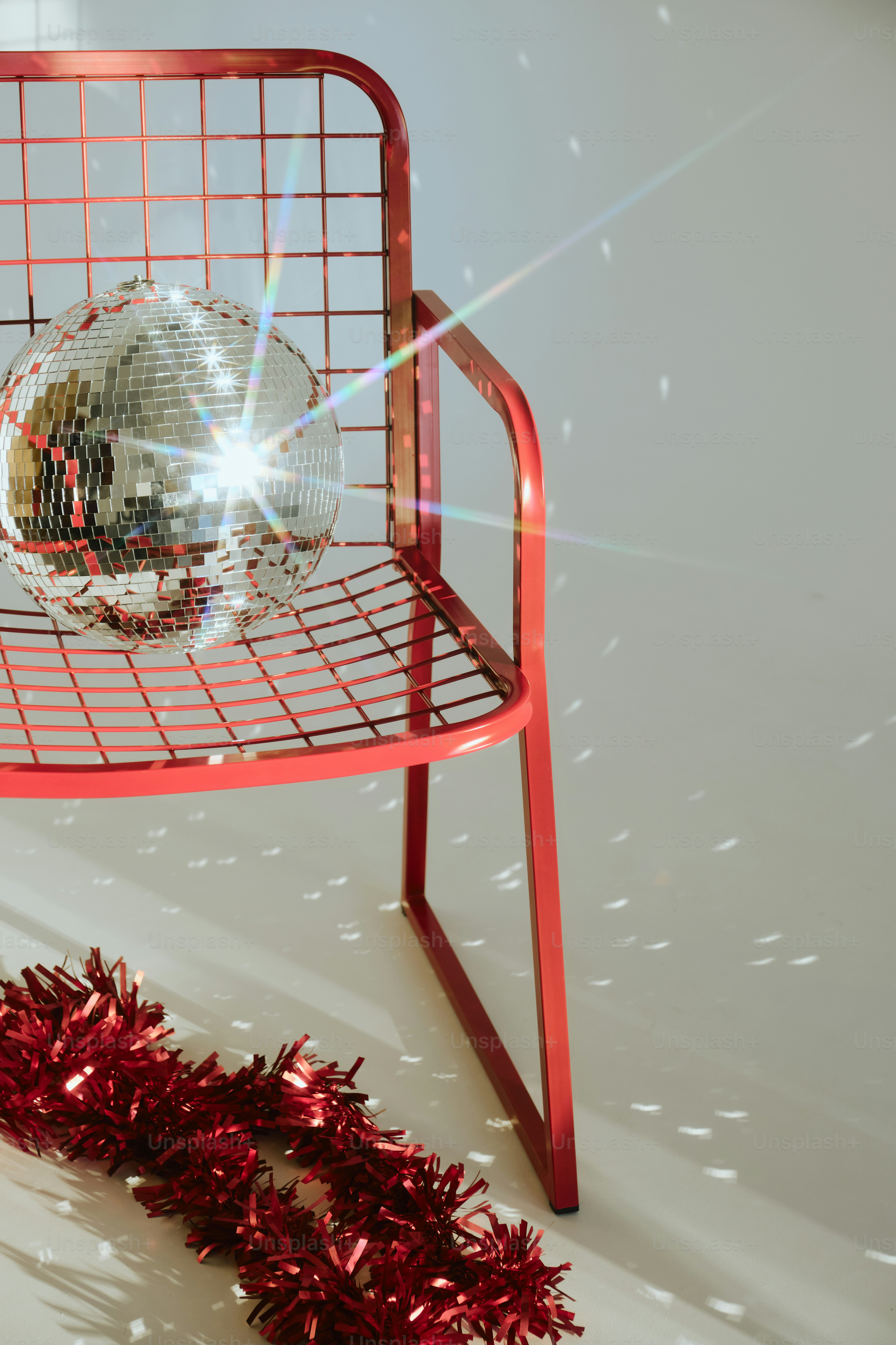 Disco ball on a red chair with tinsel. photo – Christmas Image on Unsplash