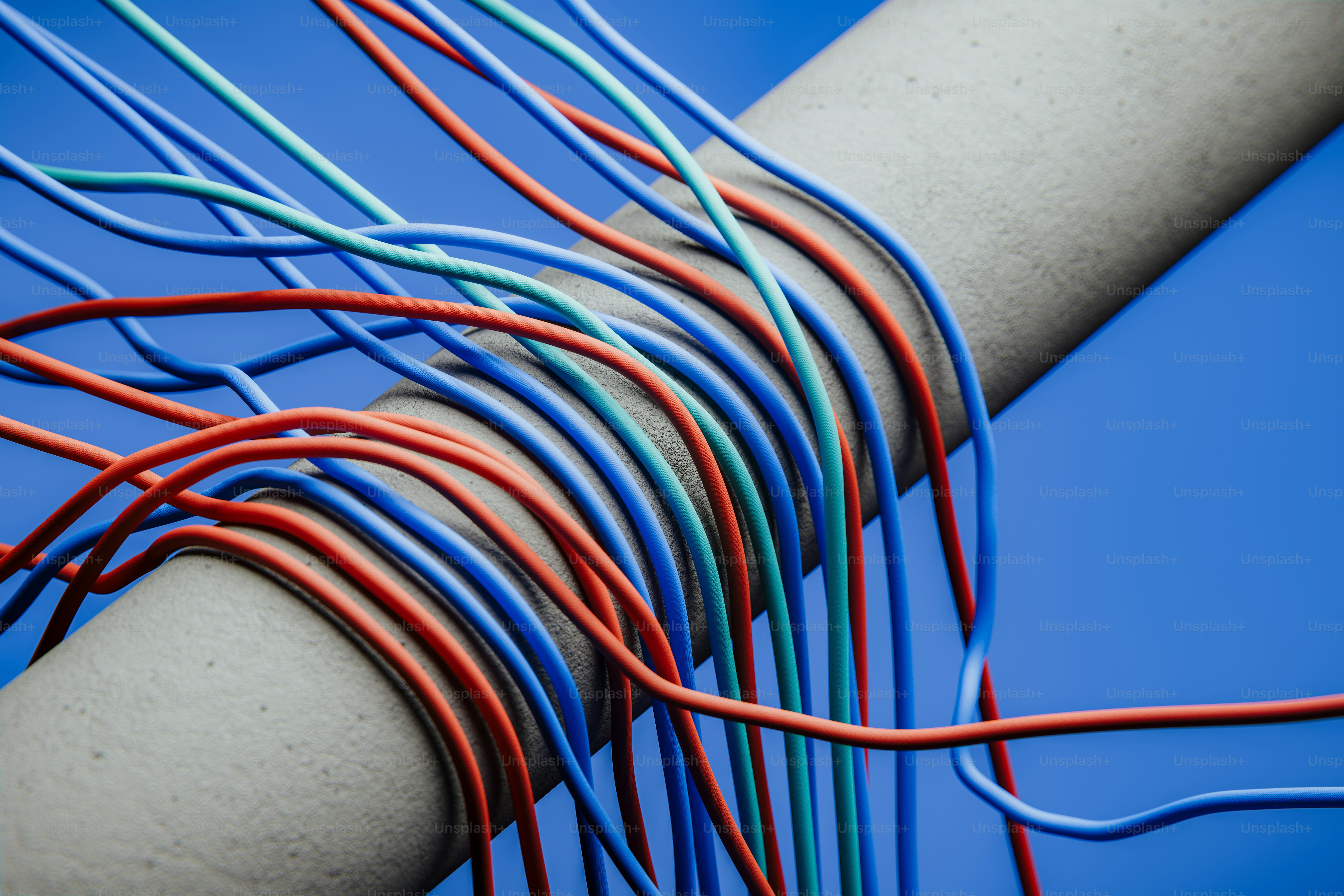 Colorful wires wrapped around a tube on blue background photo ...