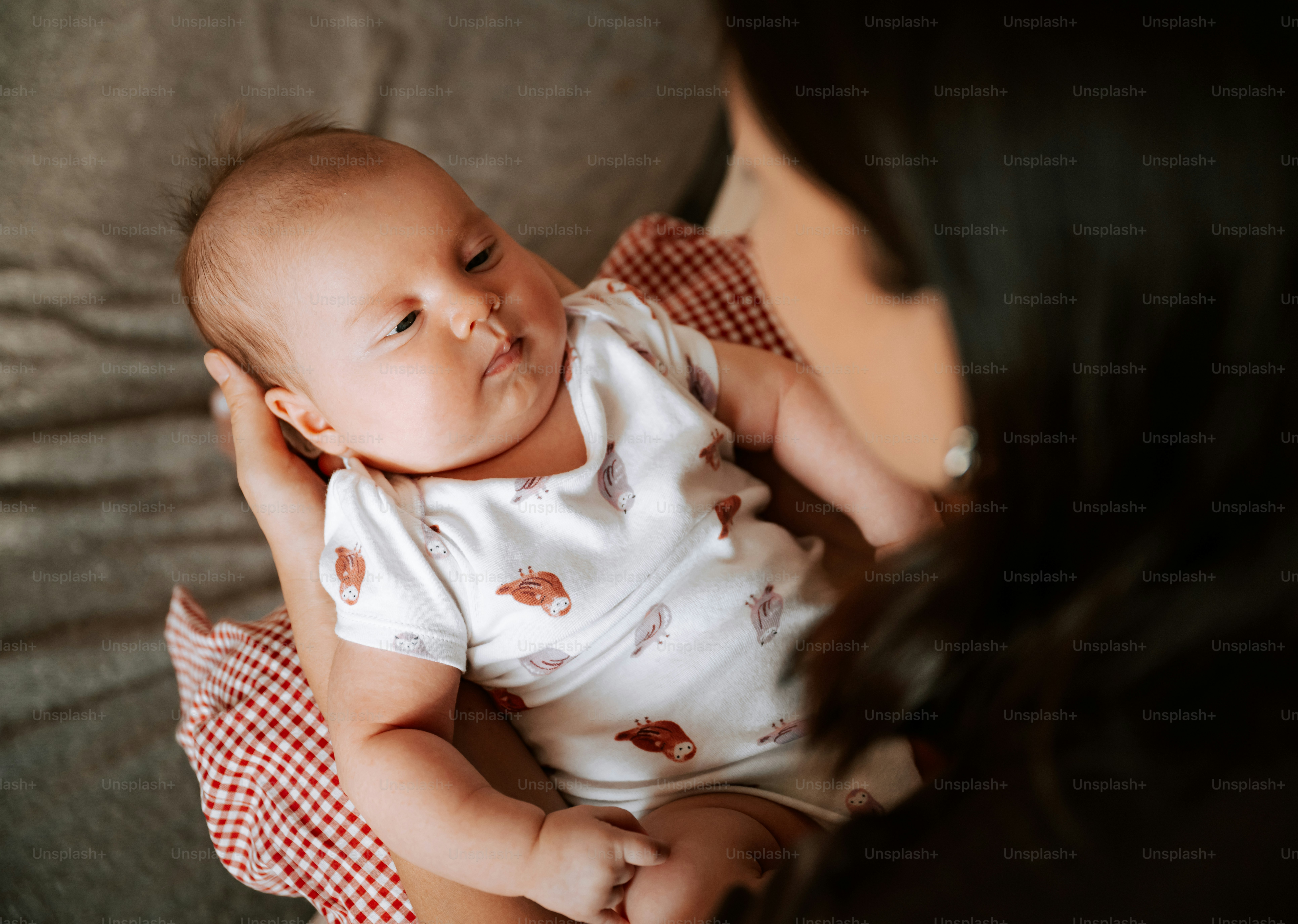 Mother holding her newborn baby gently photo – Image on Unsplash