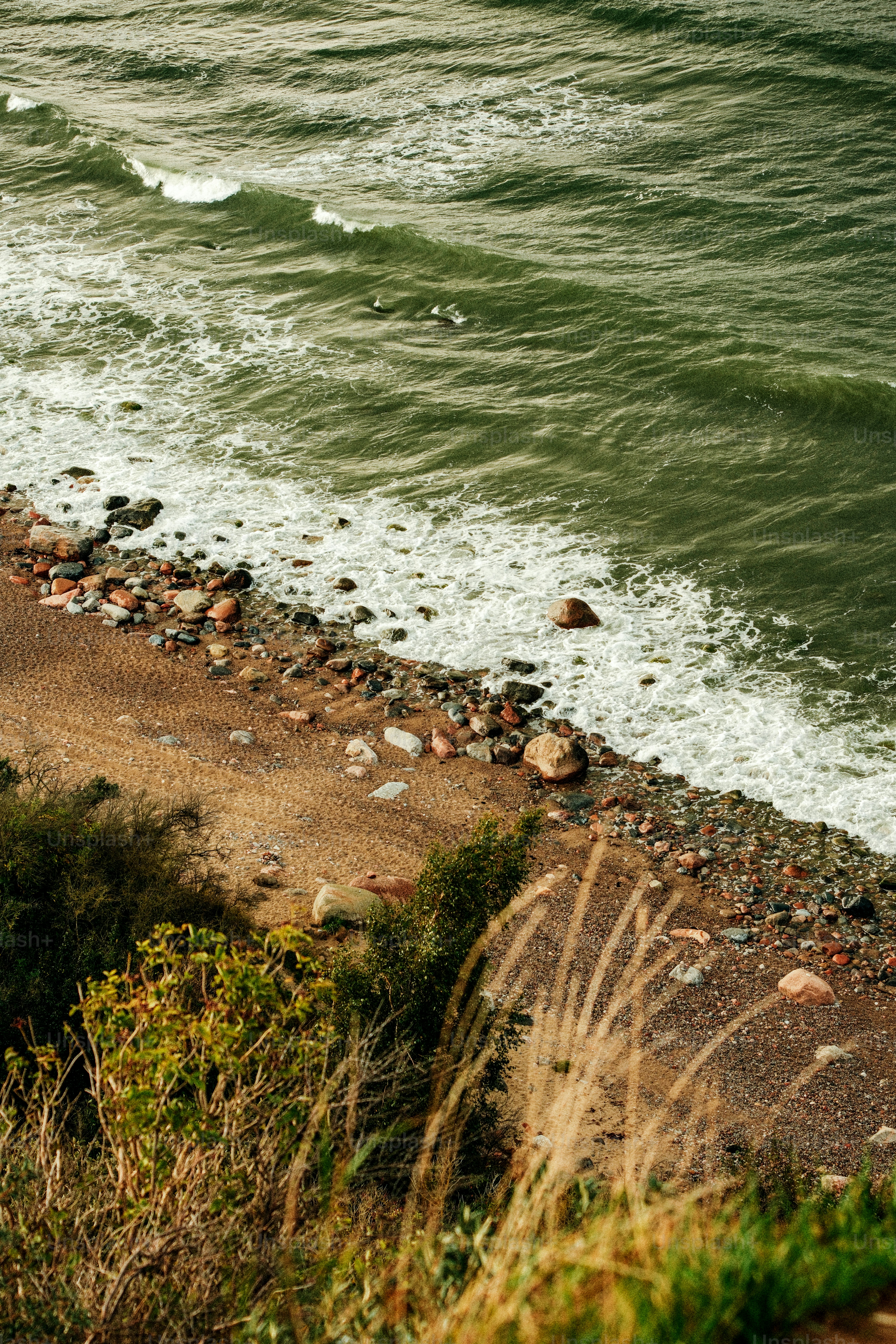 Coastal cliffs overlooking a sandy beach and ocean waves photo – Beach ...