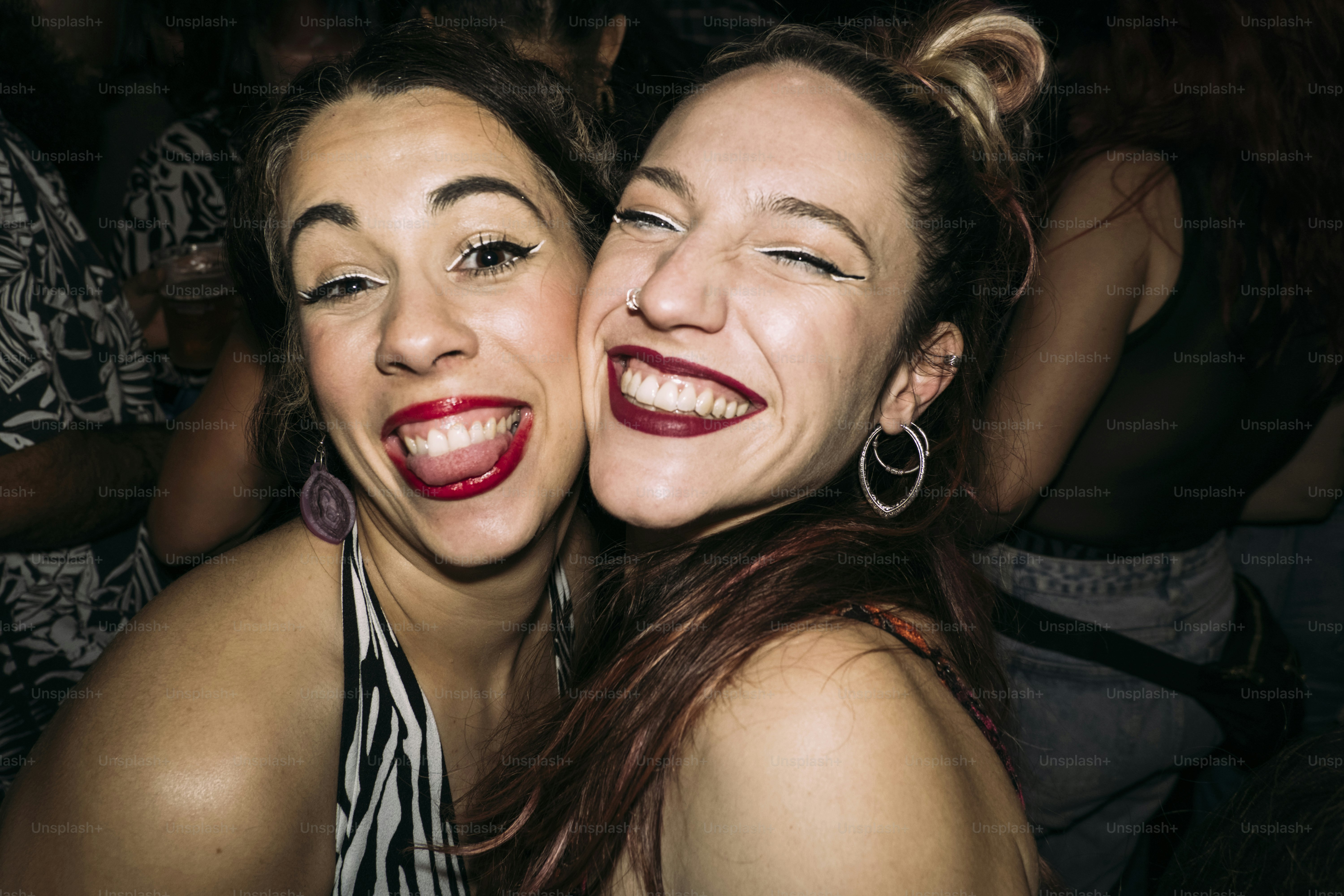 Two women dancing at a party at night. photo – Adult Image on Unsplash