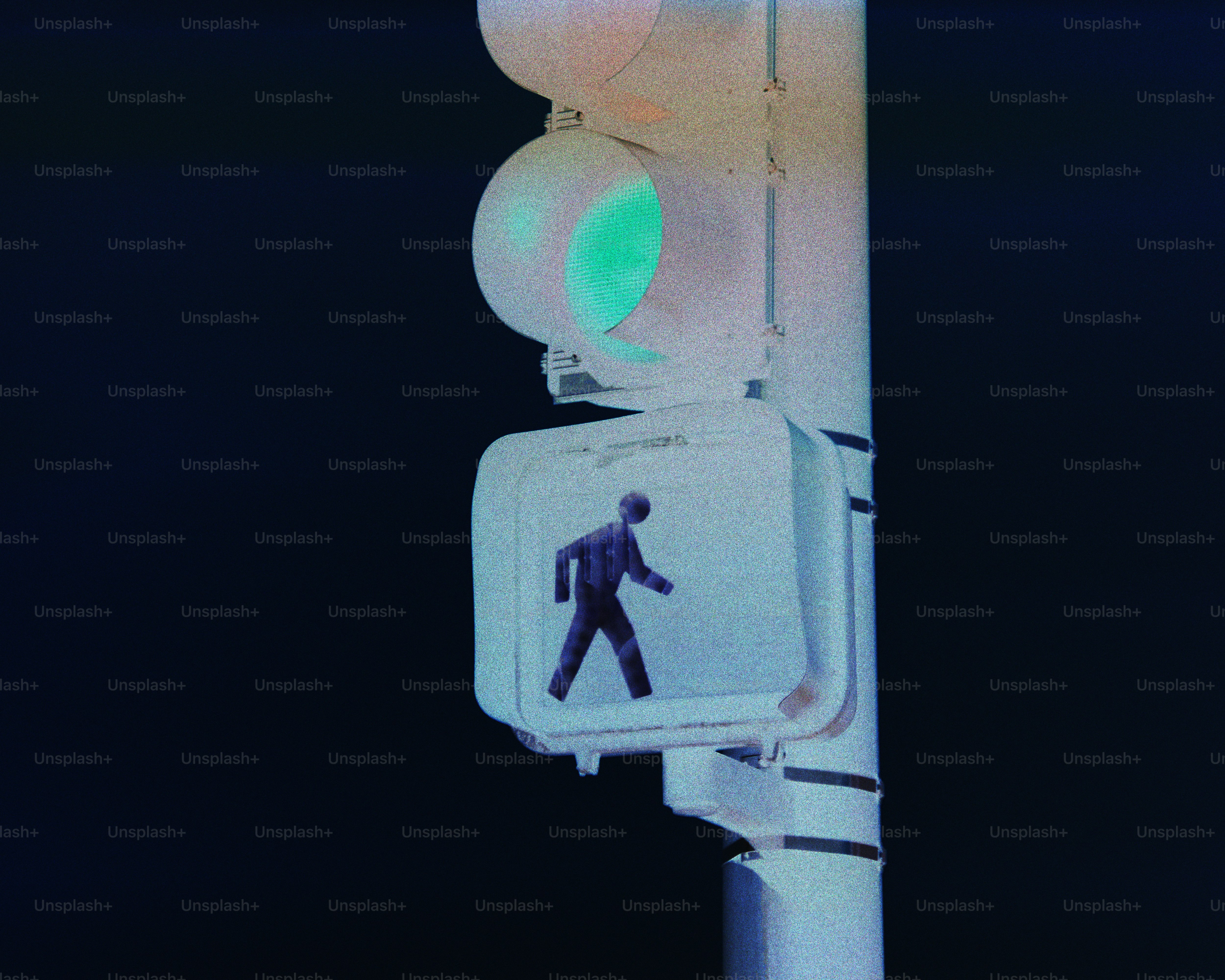 A traffic light with a green walk signal. photo – Green light Image on ...