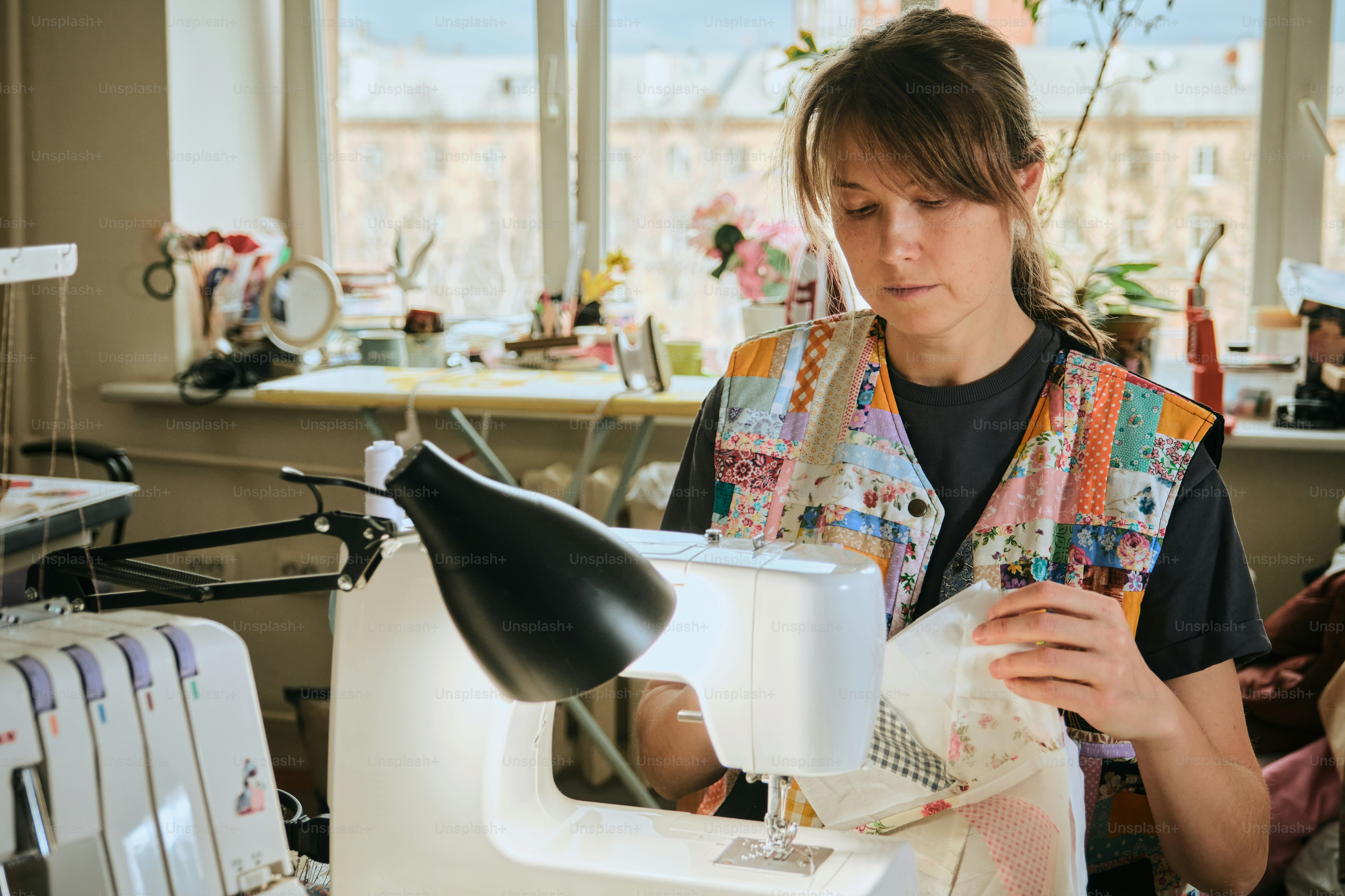 Woman sewing fabric on a sewing machine. photo – Portrait Image on Unsplash