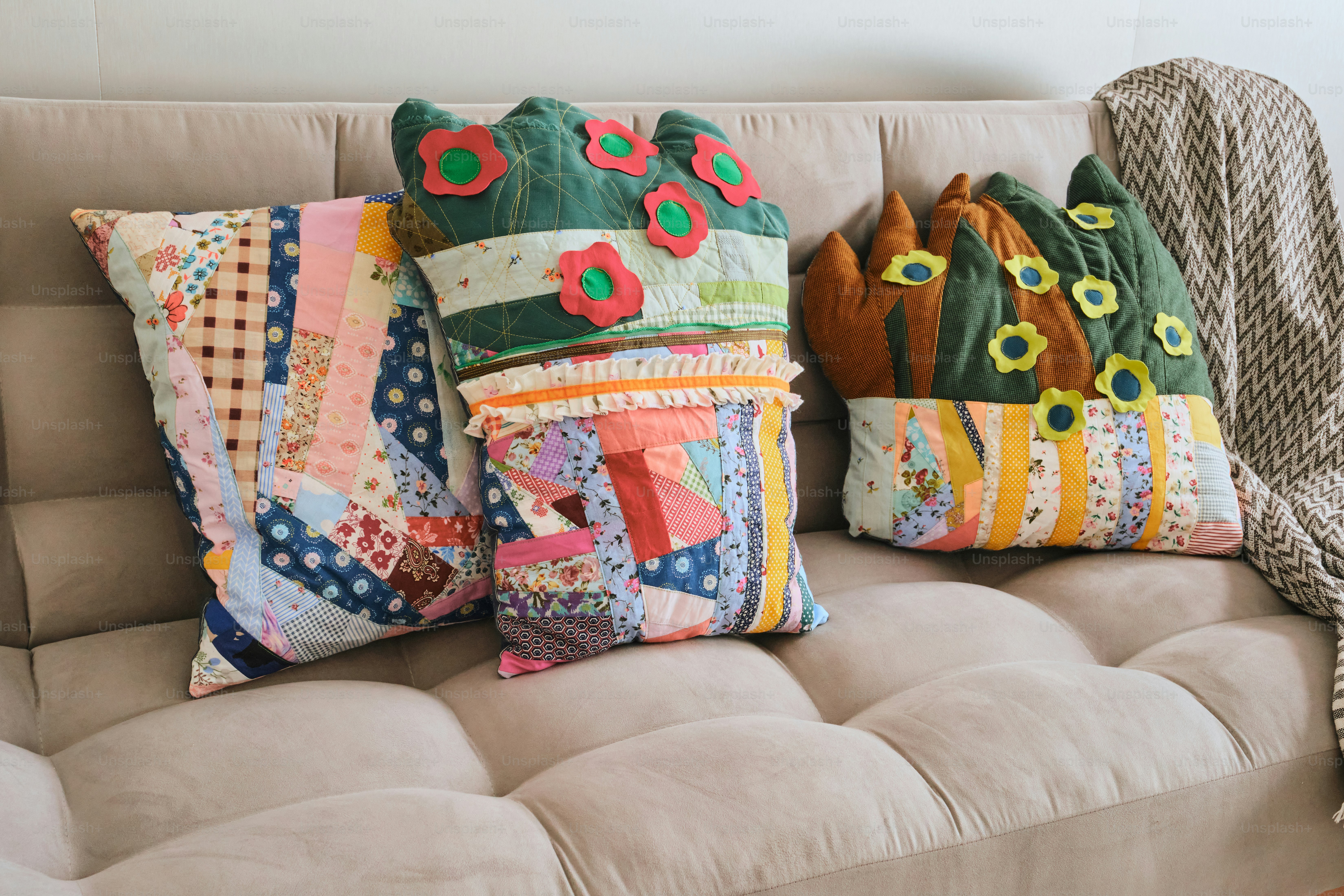 Two colorful handmade patchwork pillows on a sofa. photo – Woman Image ...